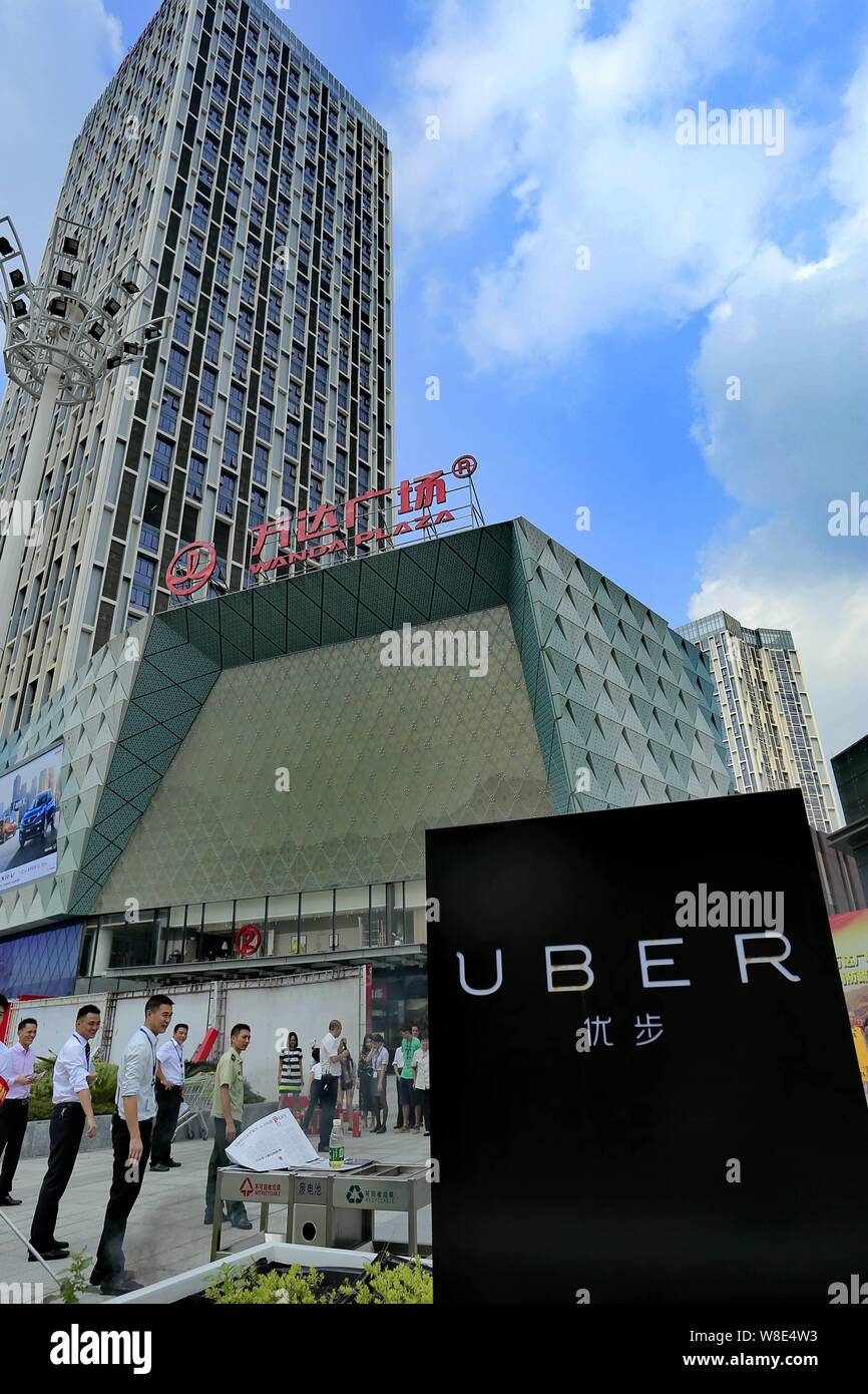 --FILE--A signboard of the taxi-hailing app Uber is seen in front of a ...
