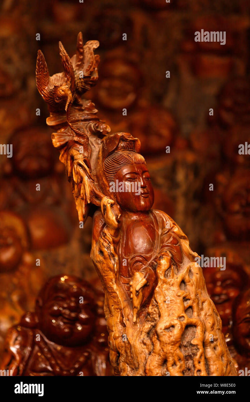 A wooden Buddha statue is on display at an exhibition center in ...