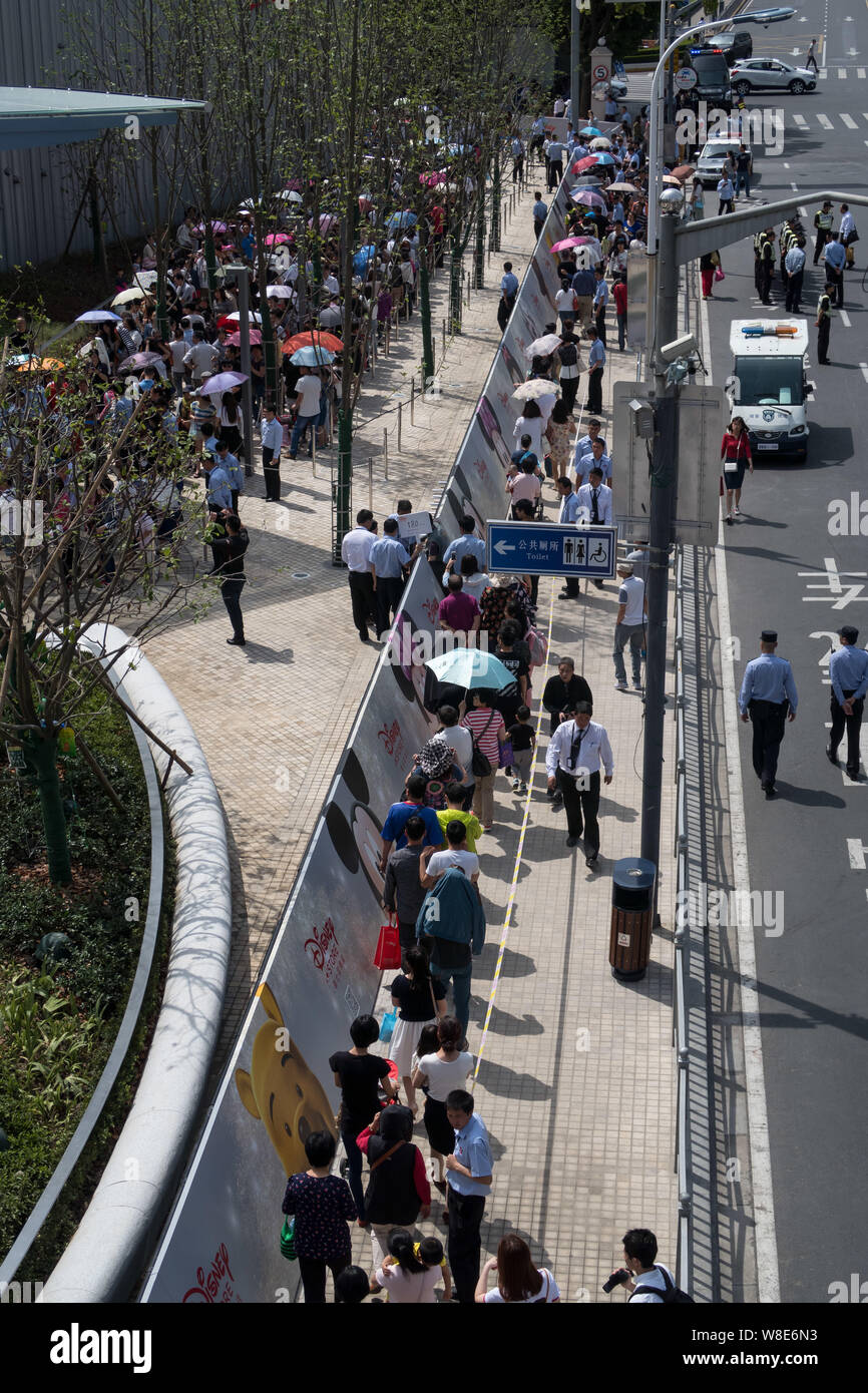Customers queue up in front of the newly-opened Shanghai Disney ...