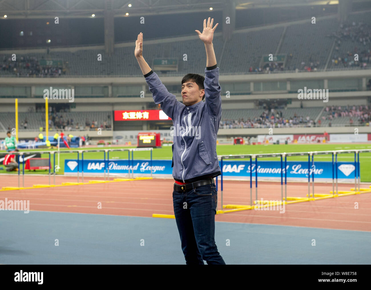 Chinese hurdler Liu Xiang waves during his retirement ceremony at the ...