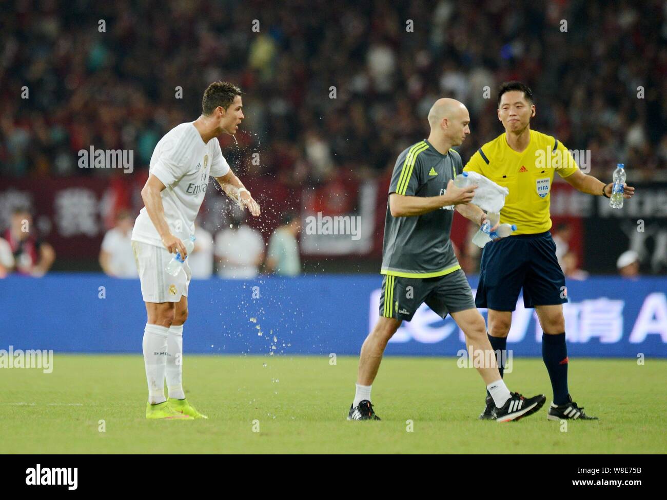 Cristiano Ronaldo of Real Madrid, left, gets a splash of water on his ...