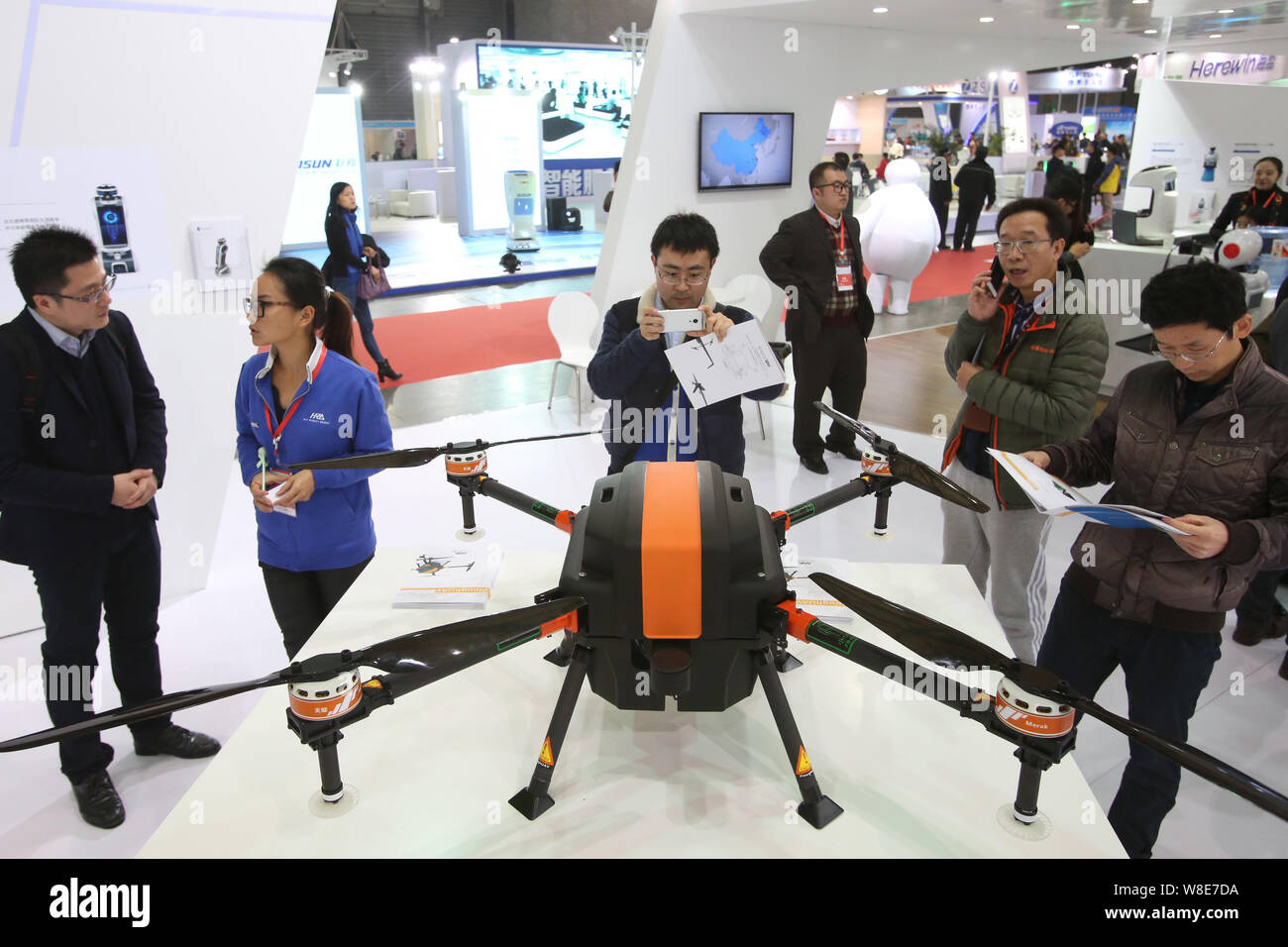 --FILE--Visitors look at a drone on display during an exhibition in ...