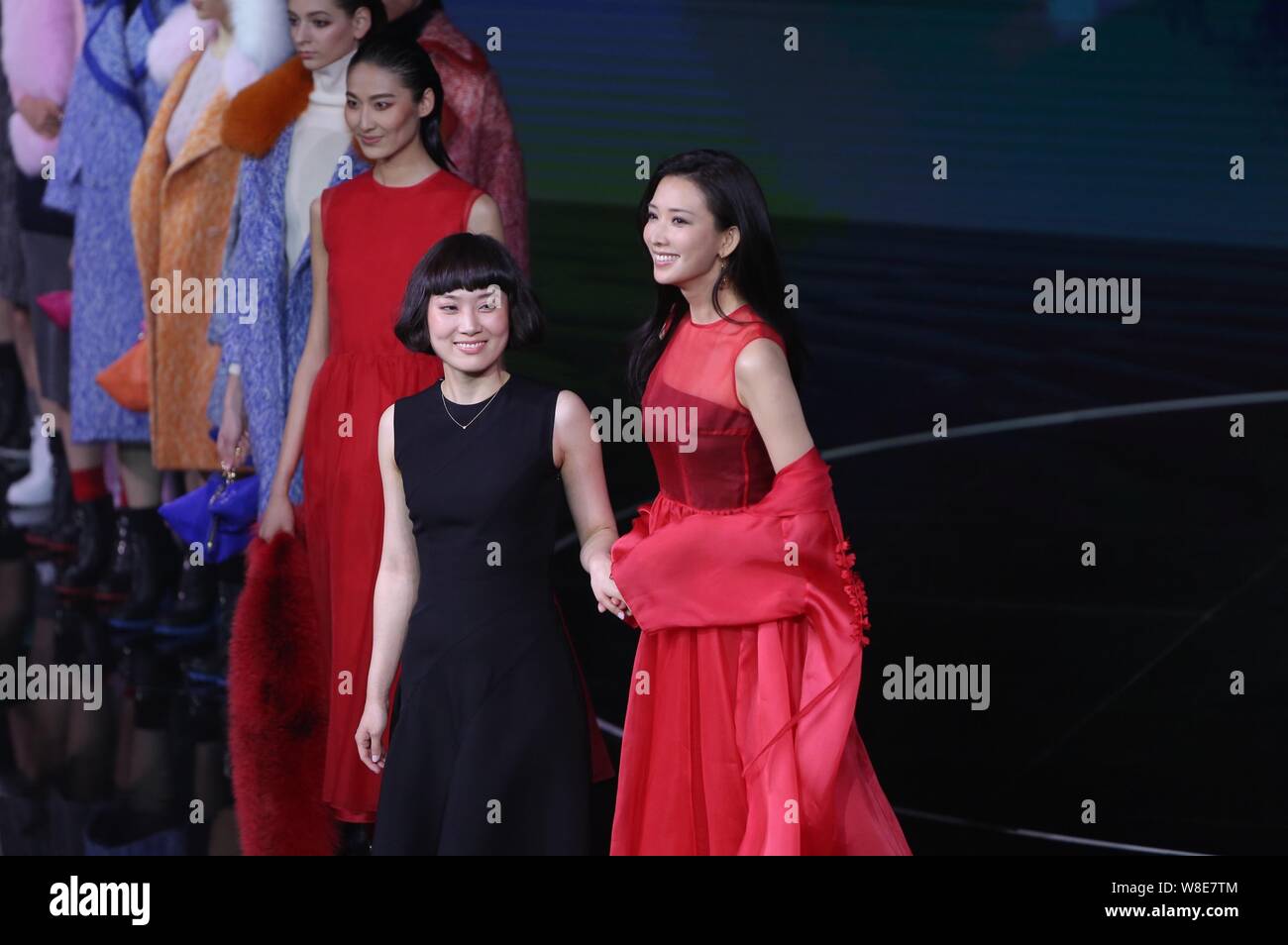 Taiwanese model and actress Lin Chi-ling, right, smiles at the fashion ...