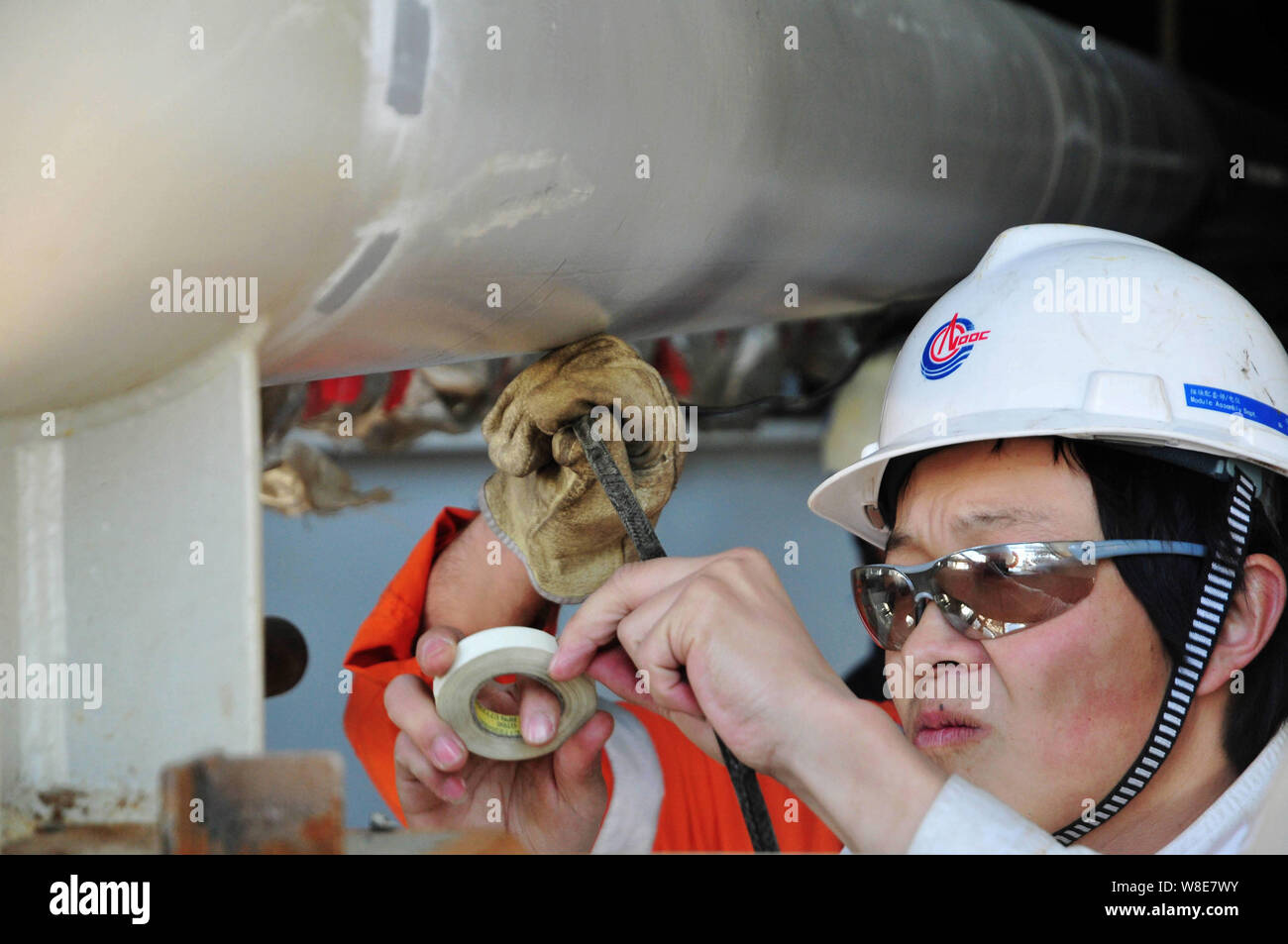 --FILE--A Chinese worker of CNOOC (China National Offshore Oil ...