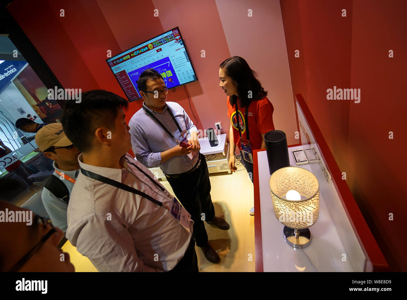A Chinese employee introduces the "smart home" eco-system to visitors ...