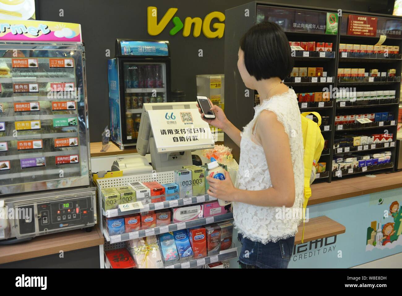 A customer scans a QR code of Alipay, a mobile payment service of ...