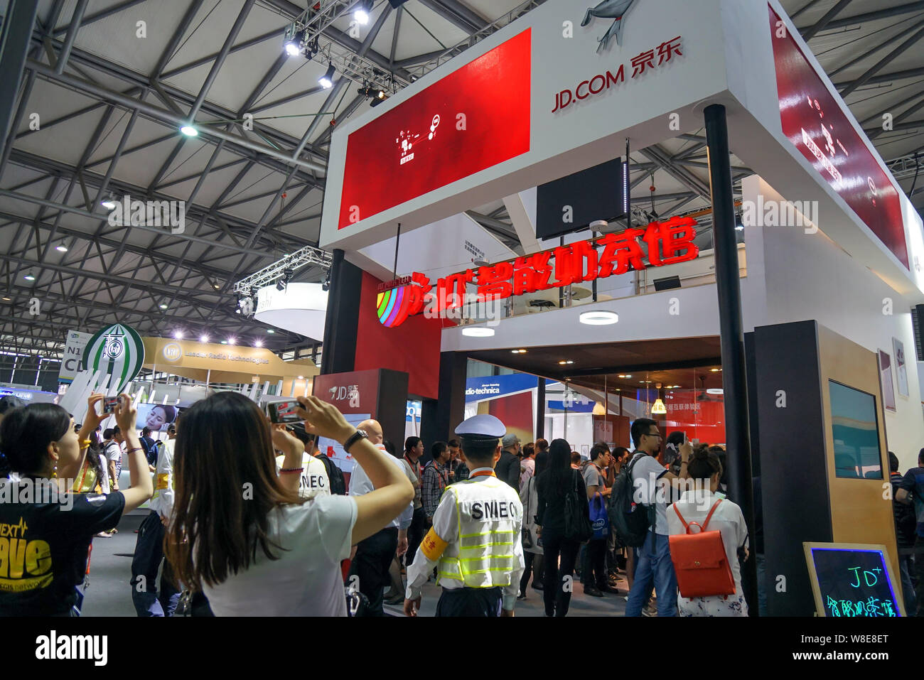 --FILE--Visitors crowd the stand of JD.com, also known as Jingdong.com ...