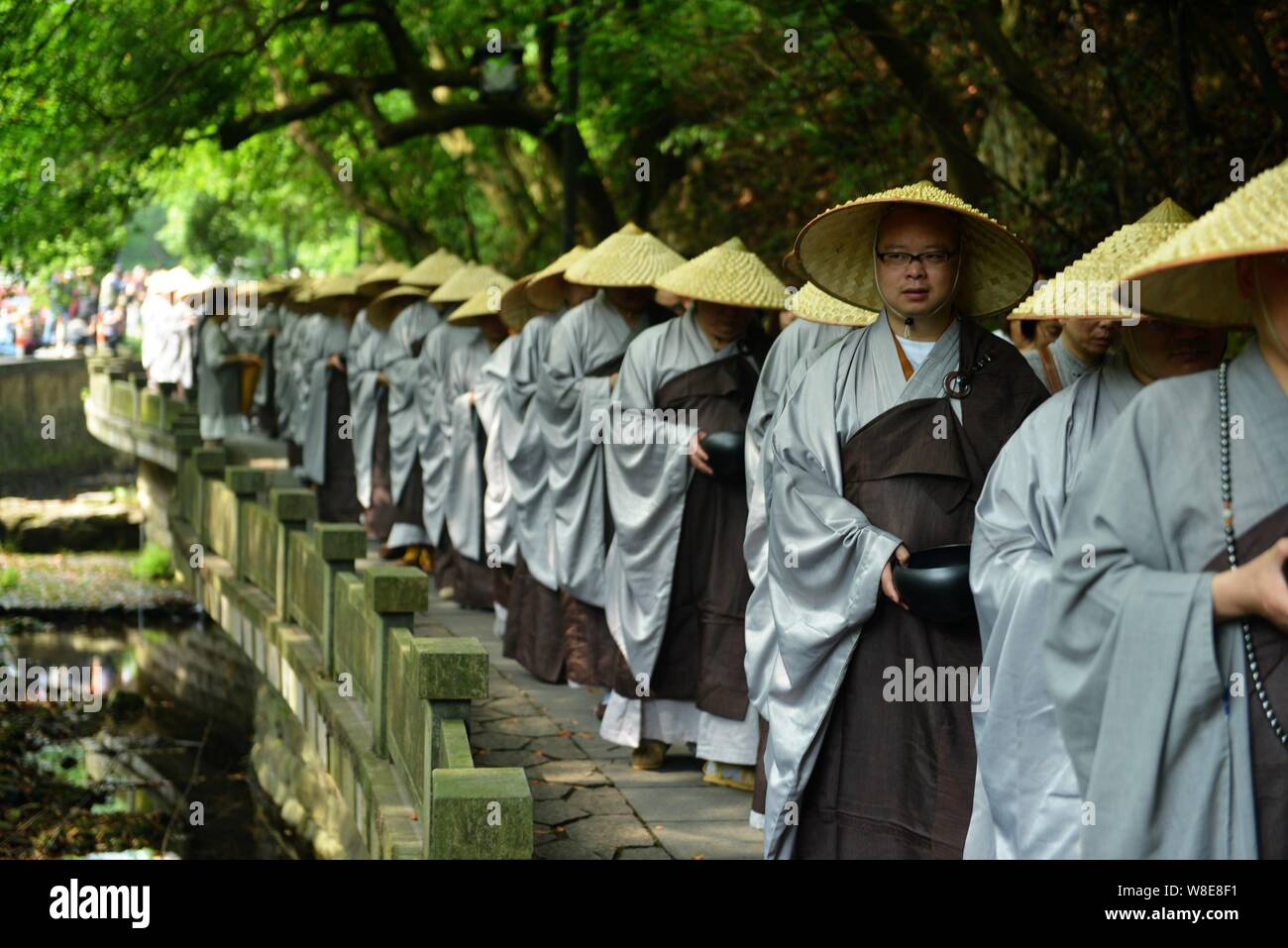 Chinese Buddhist monks holding alms bowls take part in a mendicants ...