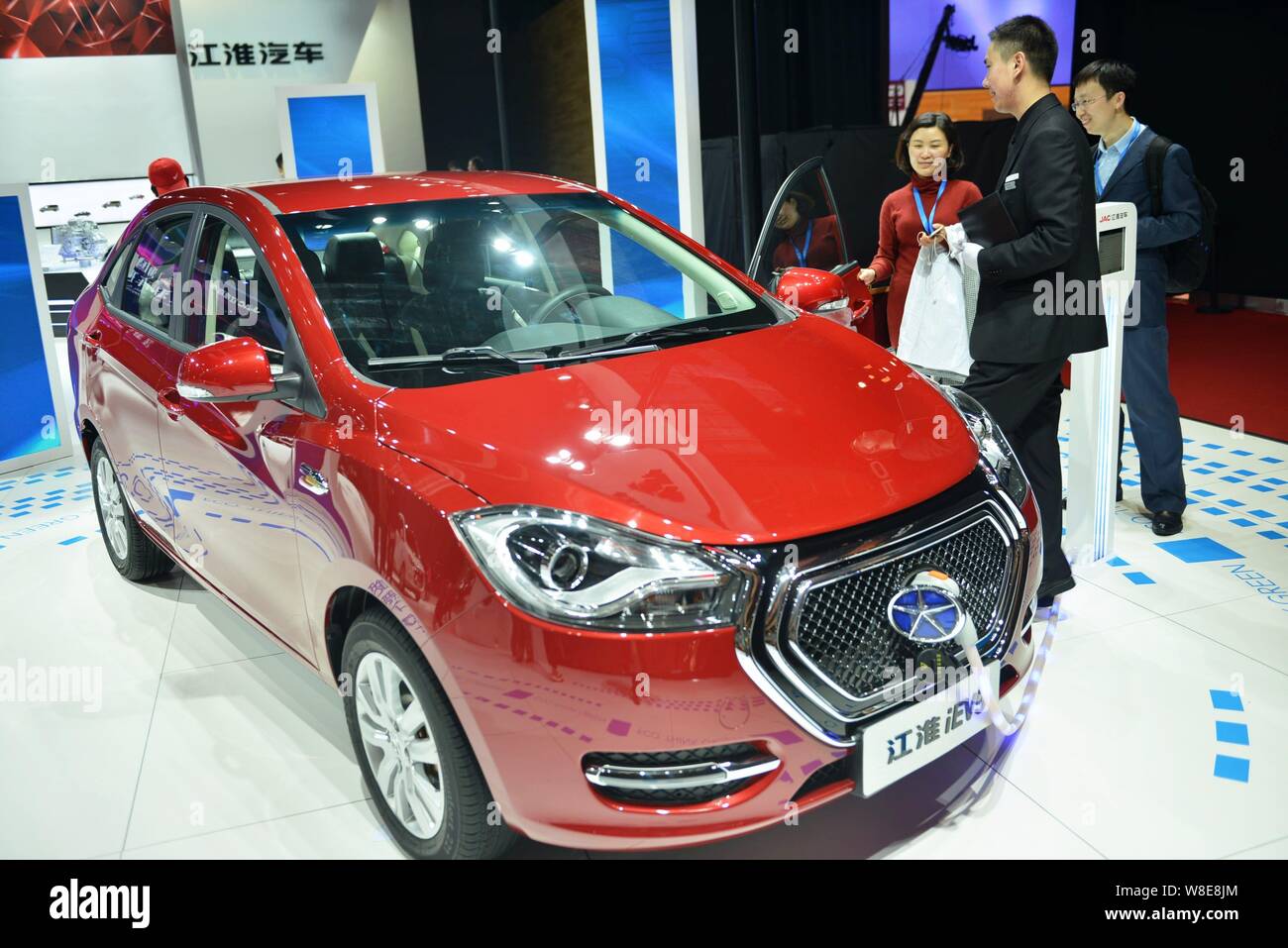 Visitors look at an iEV5 electric car of JAC on display during the 16th ...
