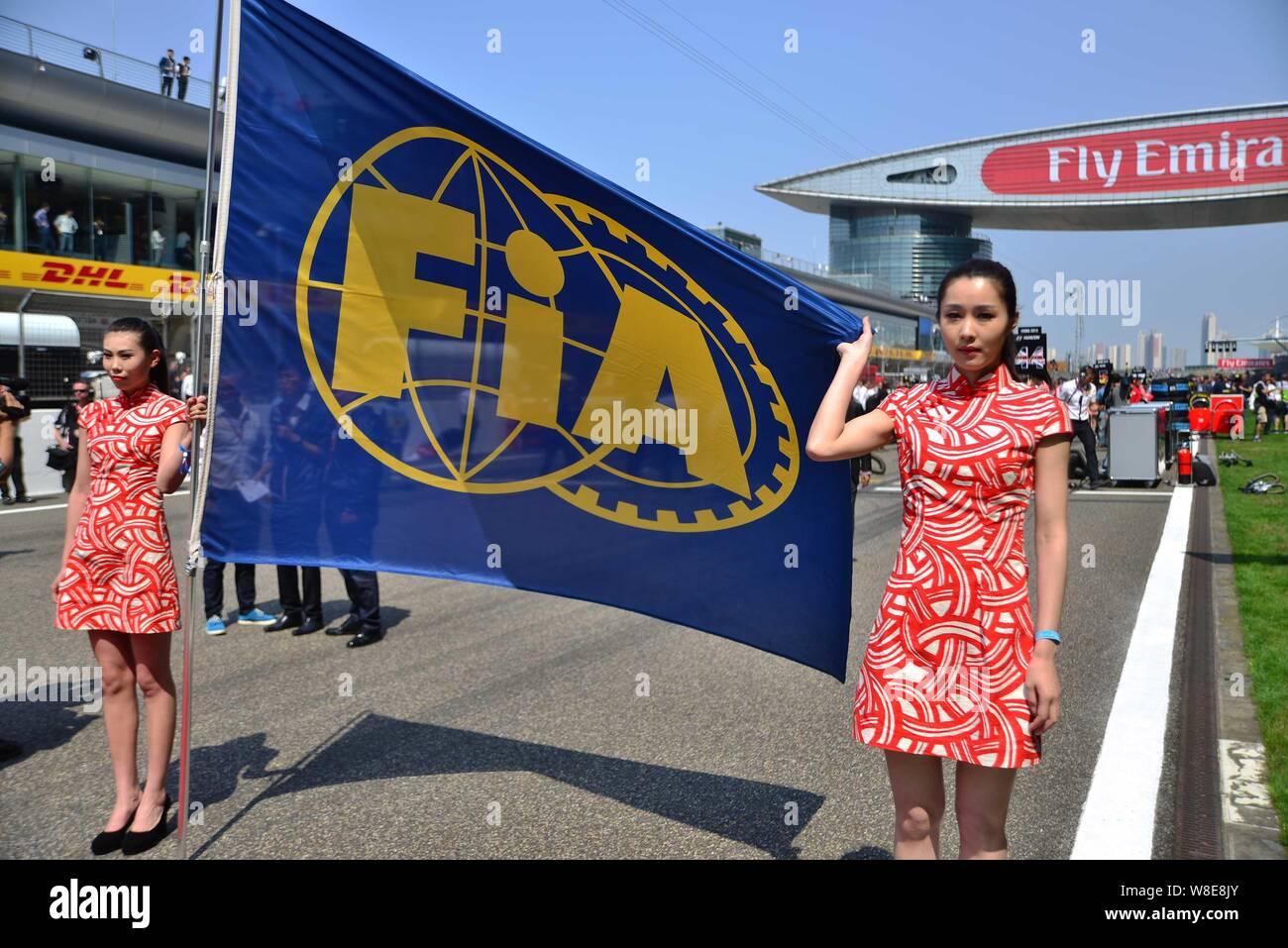 Hostesses display a flag of FIA during the 2015 Formula 1 Chinese Grand ...