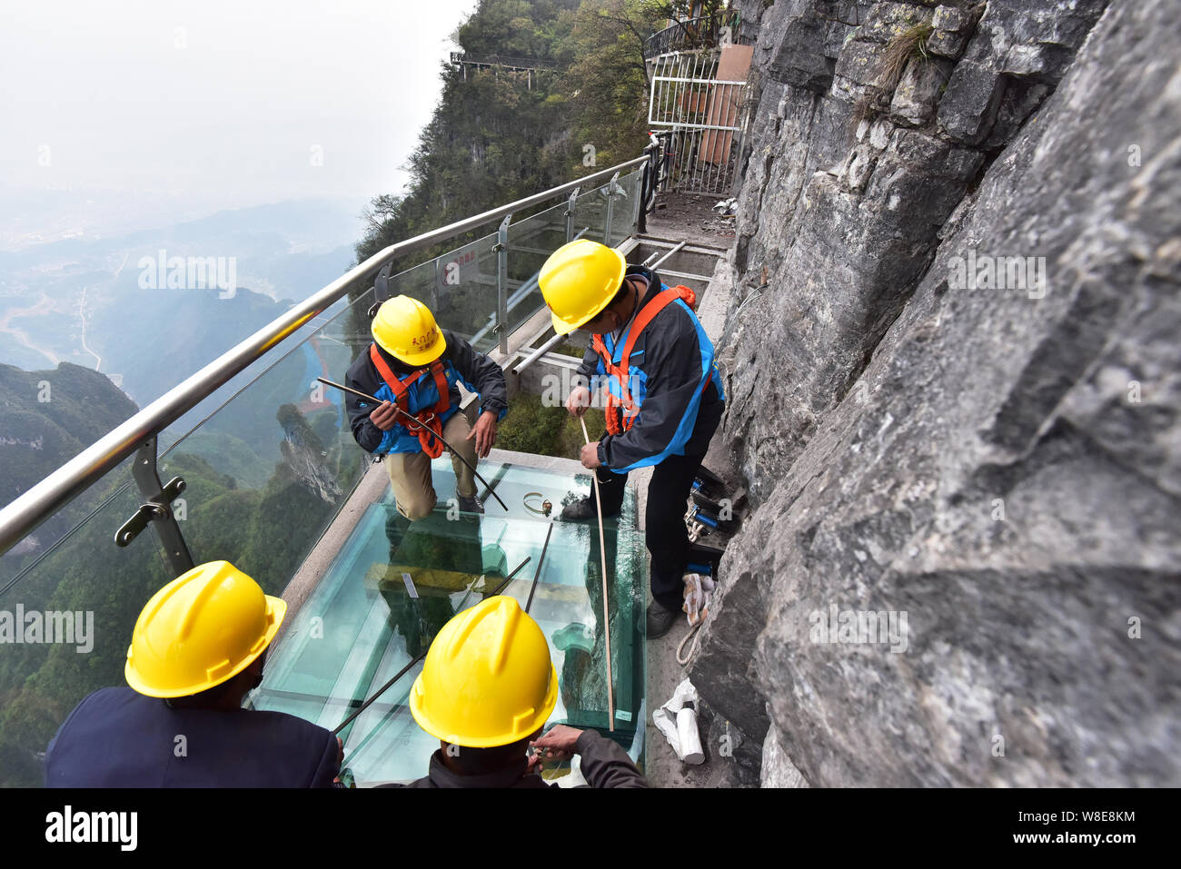 Chinese workers install the final piece of glass on the skywalk on the ...