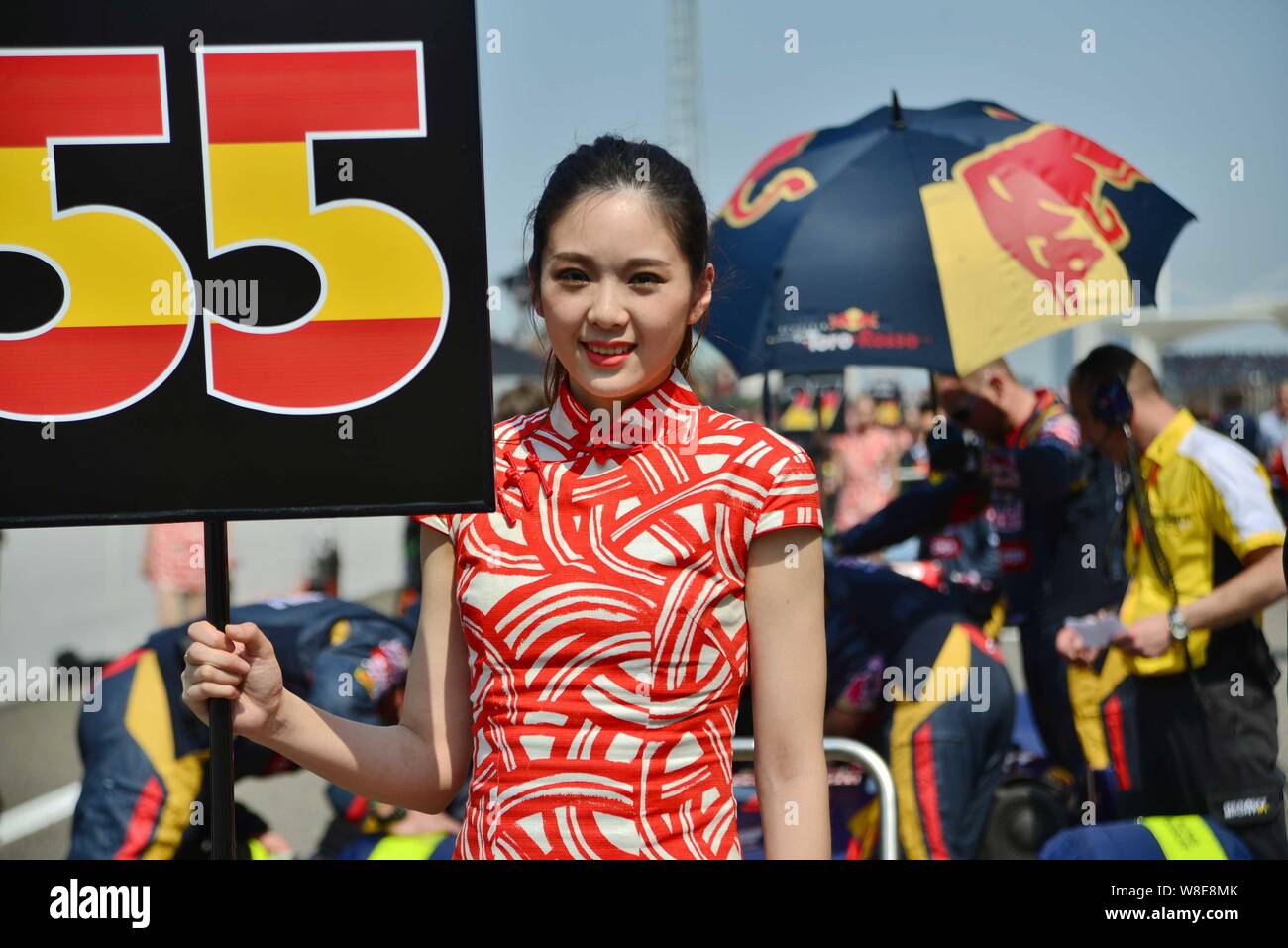 A hostess poses in front of the racing car of Spain's Carlos Sainz of ...