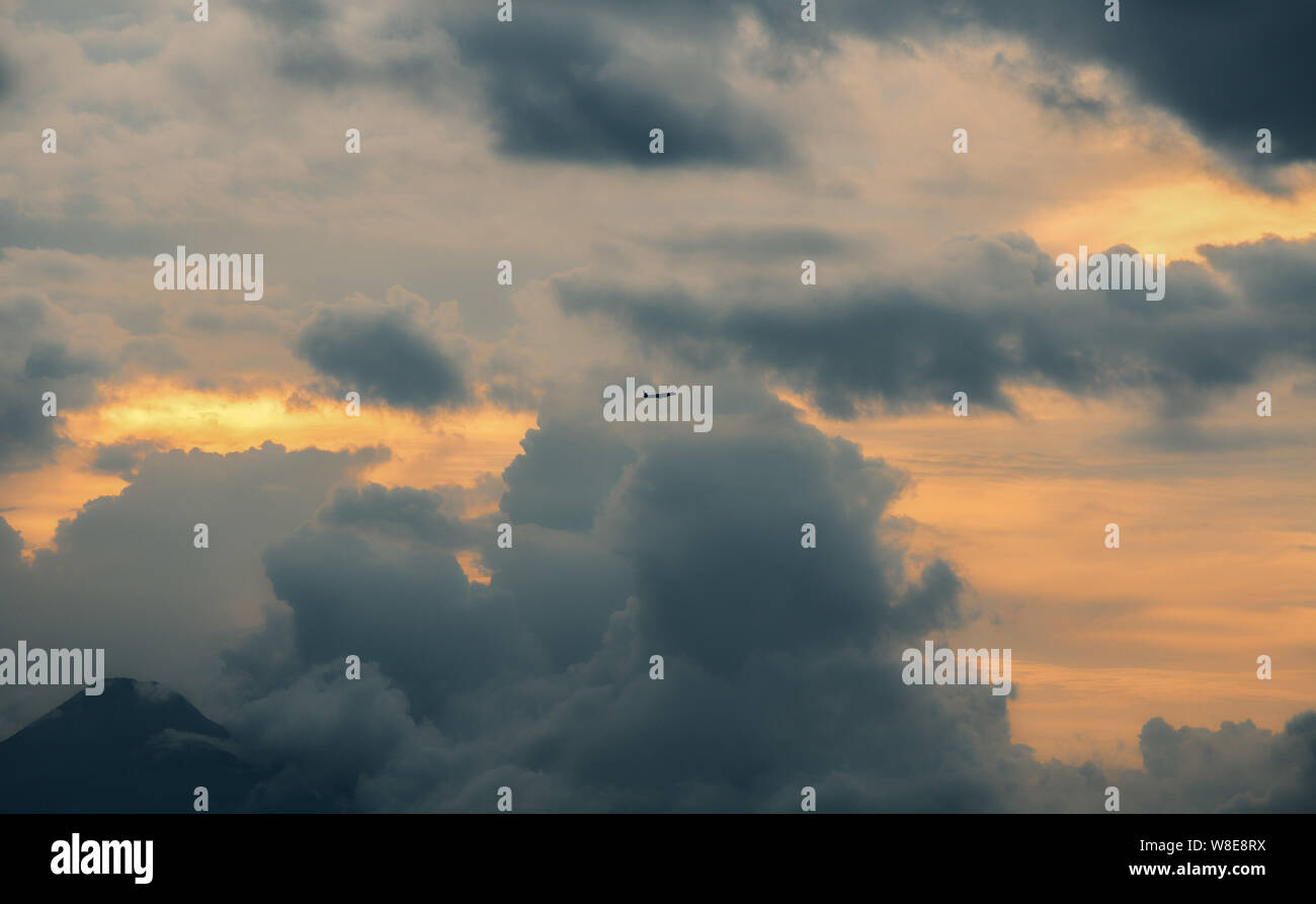 The sky with rain clouds in the evening, there are planes flying ...