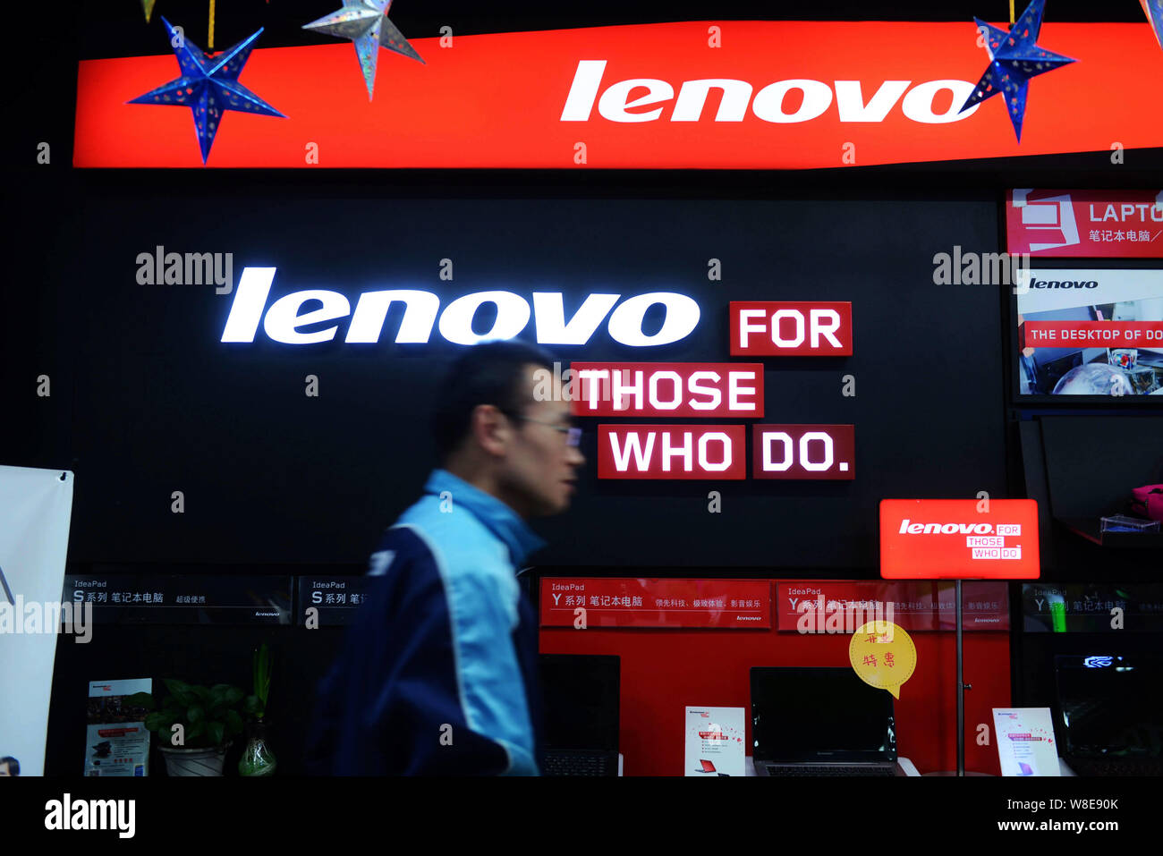 A customer walks past Lenovo laptop computers at a store in Qingdao ...