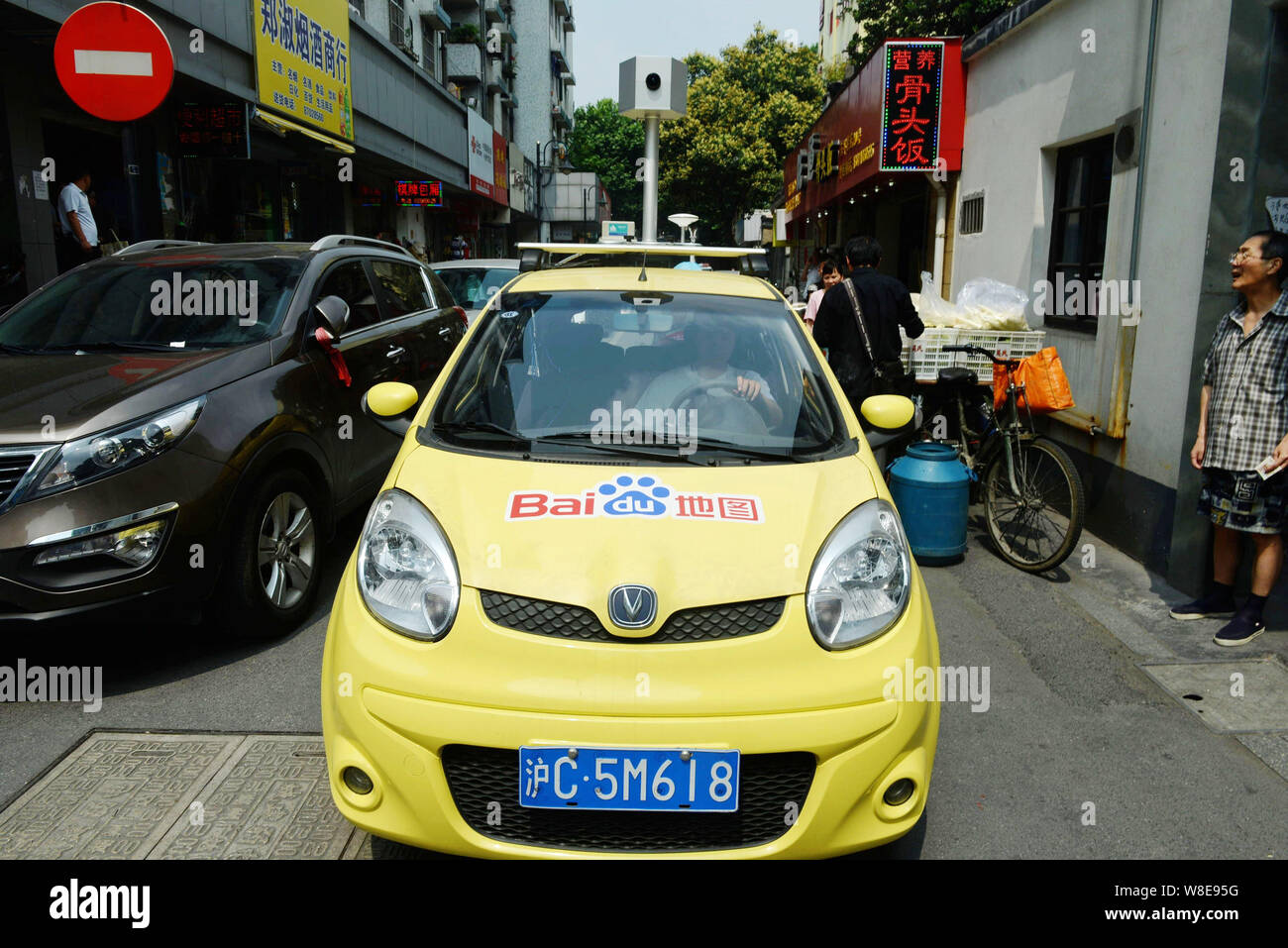 --FILE--A Chinese worker drives a car used for mapping projects of ...