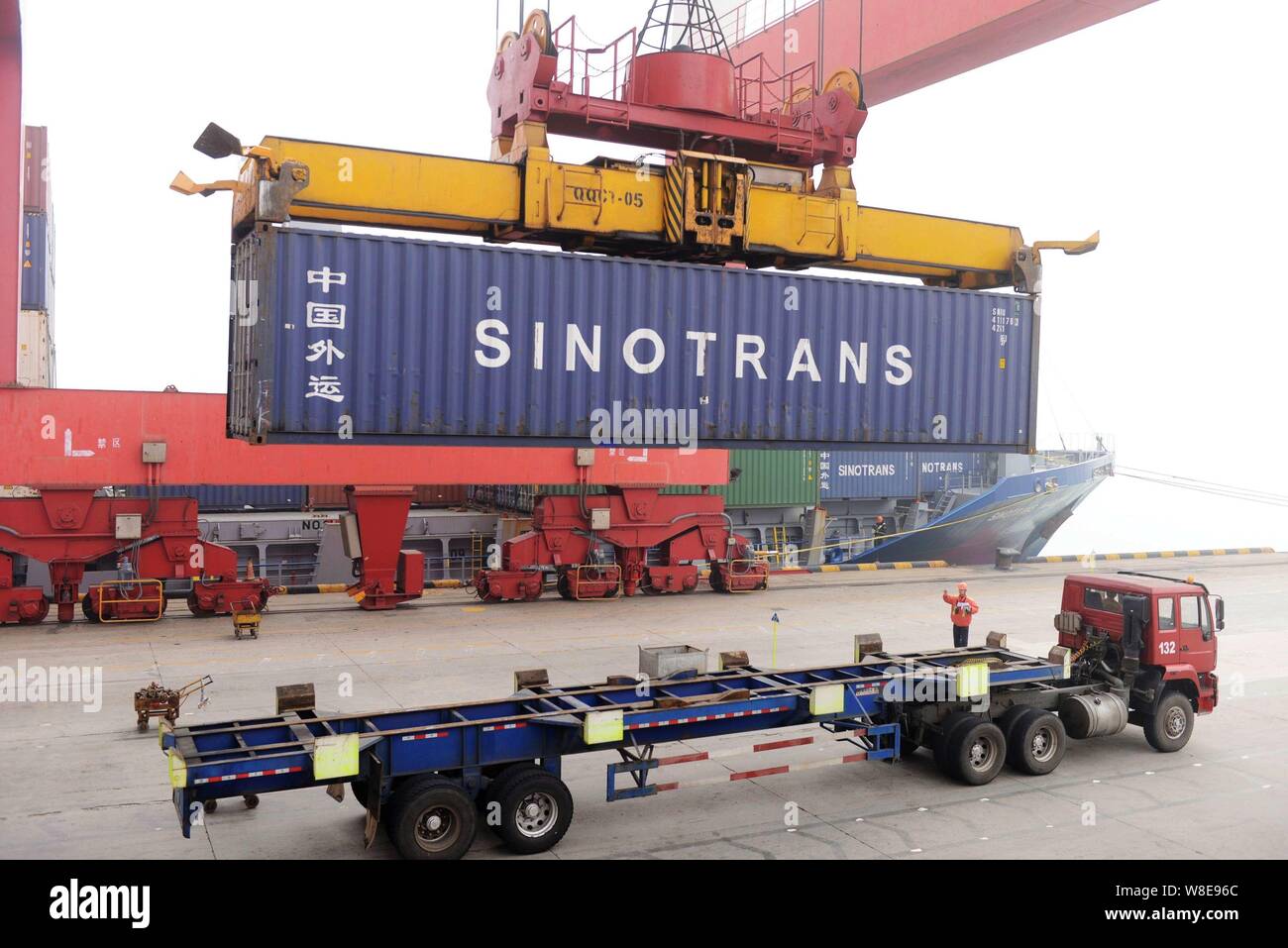 --FILE--A crane vehicle unloads a container of Sinotrans to be shipped ...