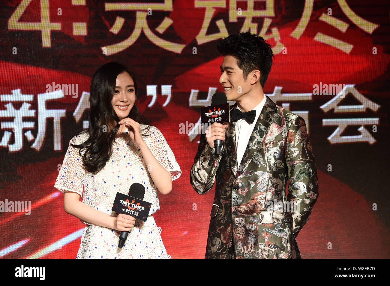 Chinese actress Yang Mi, left, smiles as actor Chen Xuedong speaks ...