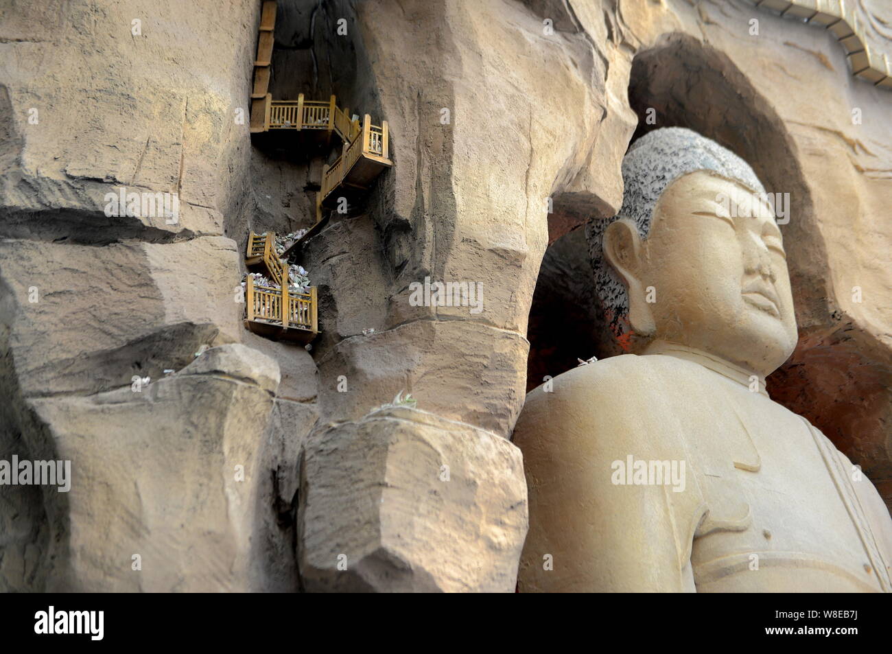 Banknotes thrown by believers are placed near Buddha statues to pray ...
