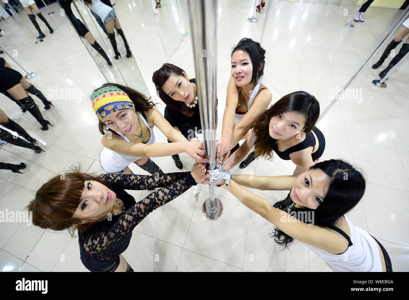 --FILE--Pole dancing learners pose at a dance training center in Jinan ...