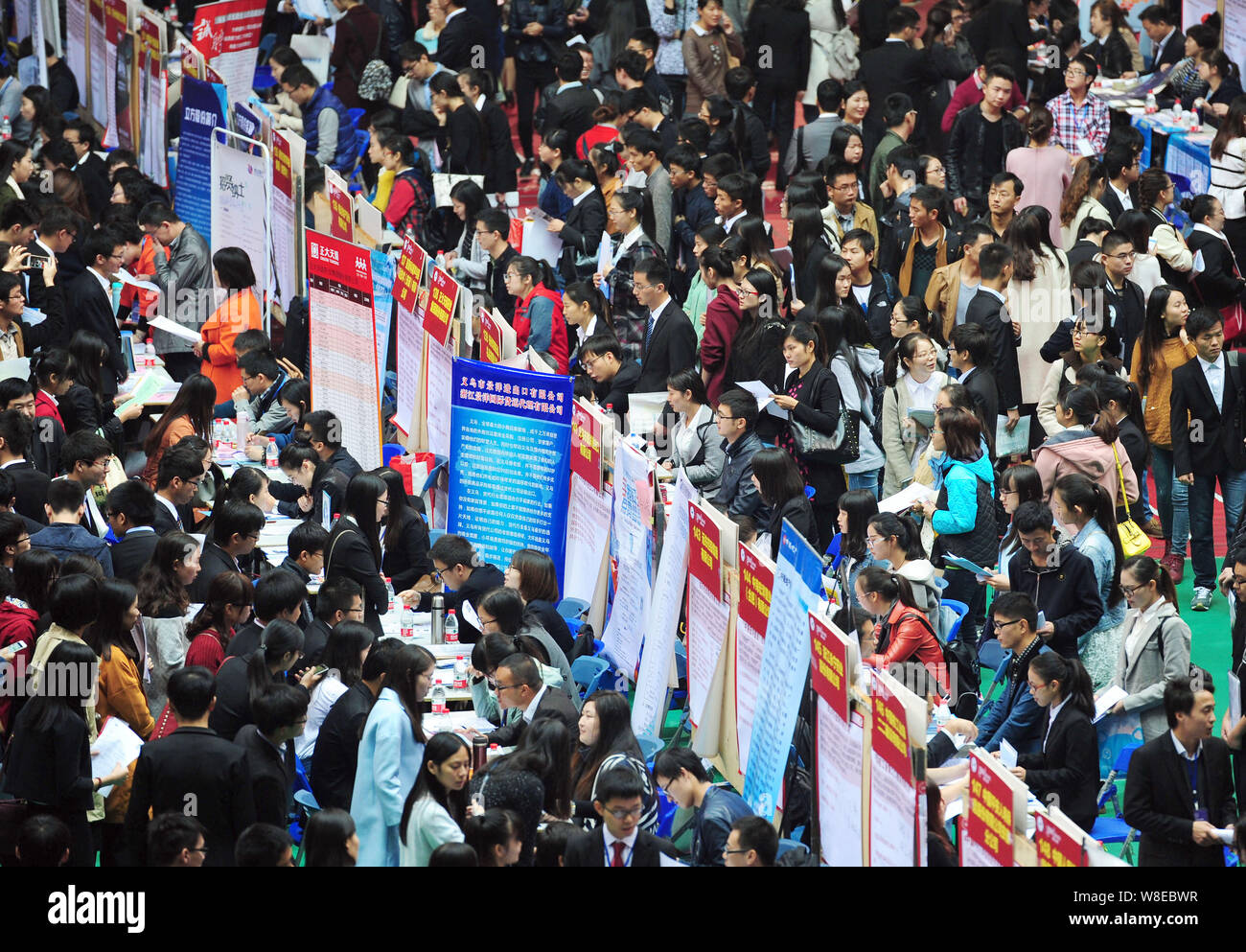 Chinese students and graduates crowd booths during a job fair at Anhui ...