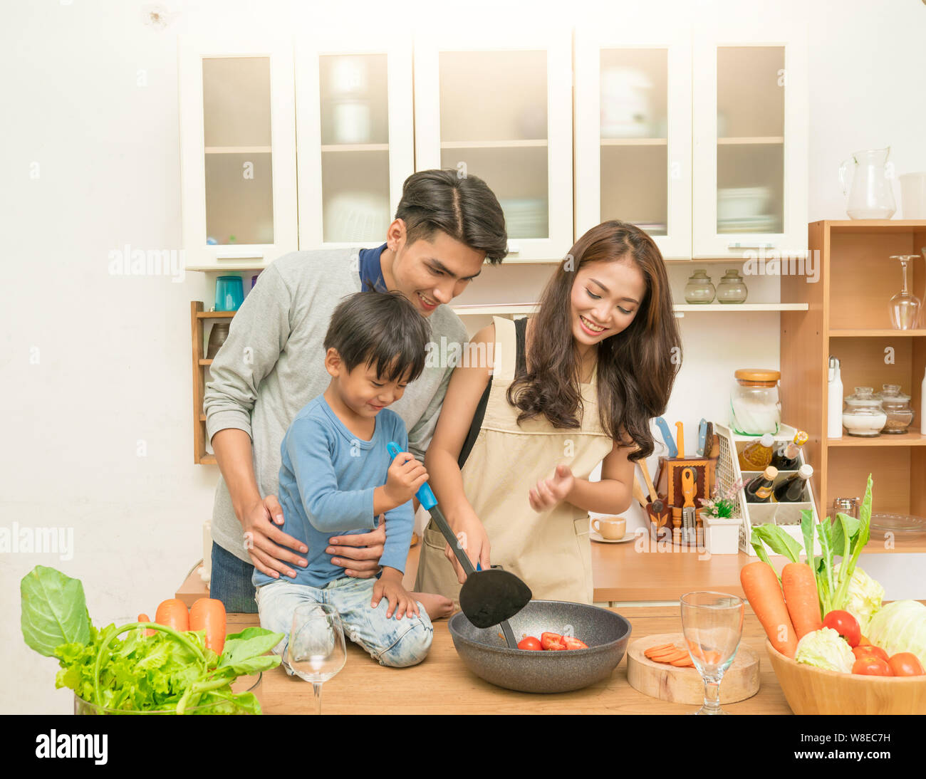 Asian family cooking in the kitchen Stock Photo - Alamy