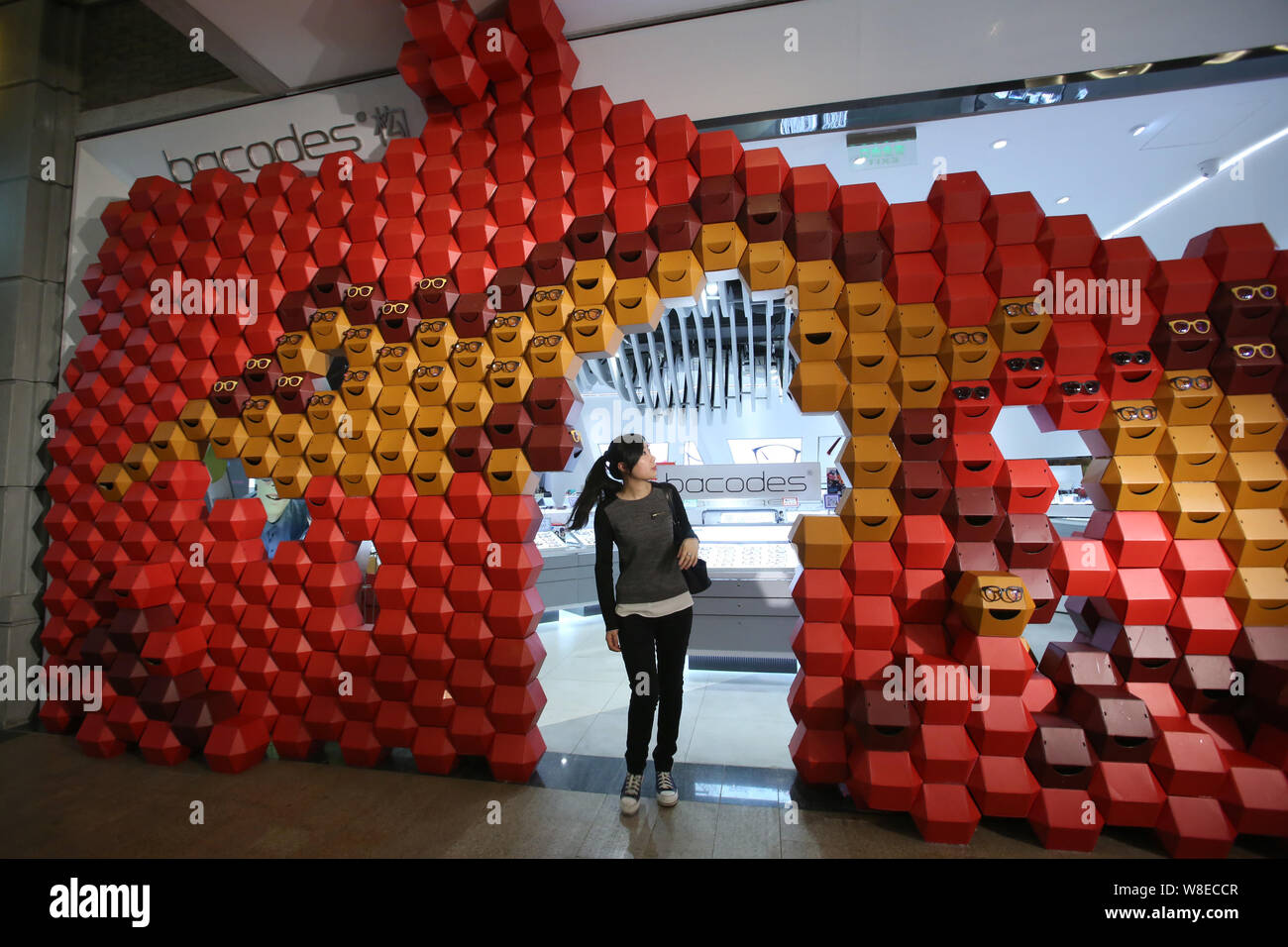 A visitor walks through an art installation during a shop window design ...