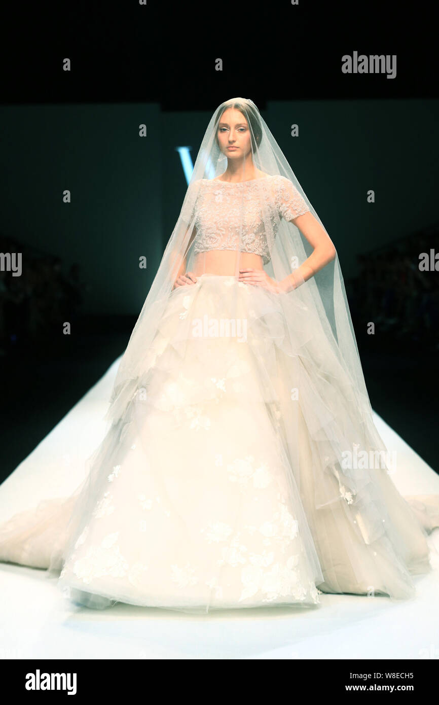 A model displays a new creation at the fashion show of Chinese wedding dress brand We Couture ...