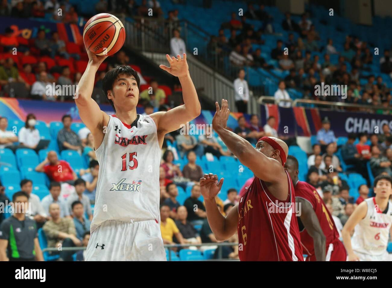 Joji Takeuchi of Japan, left, passes the ball against Saad Abdulrahman ...