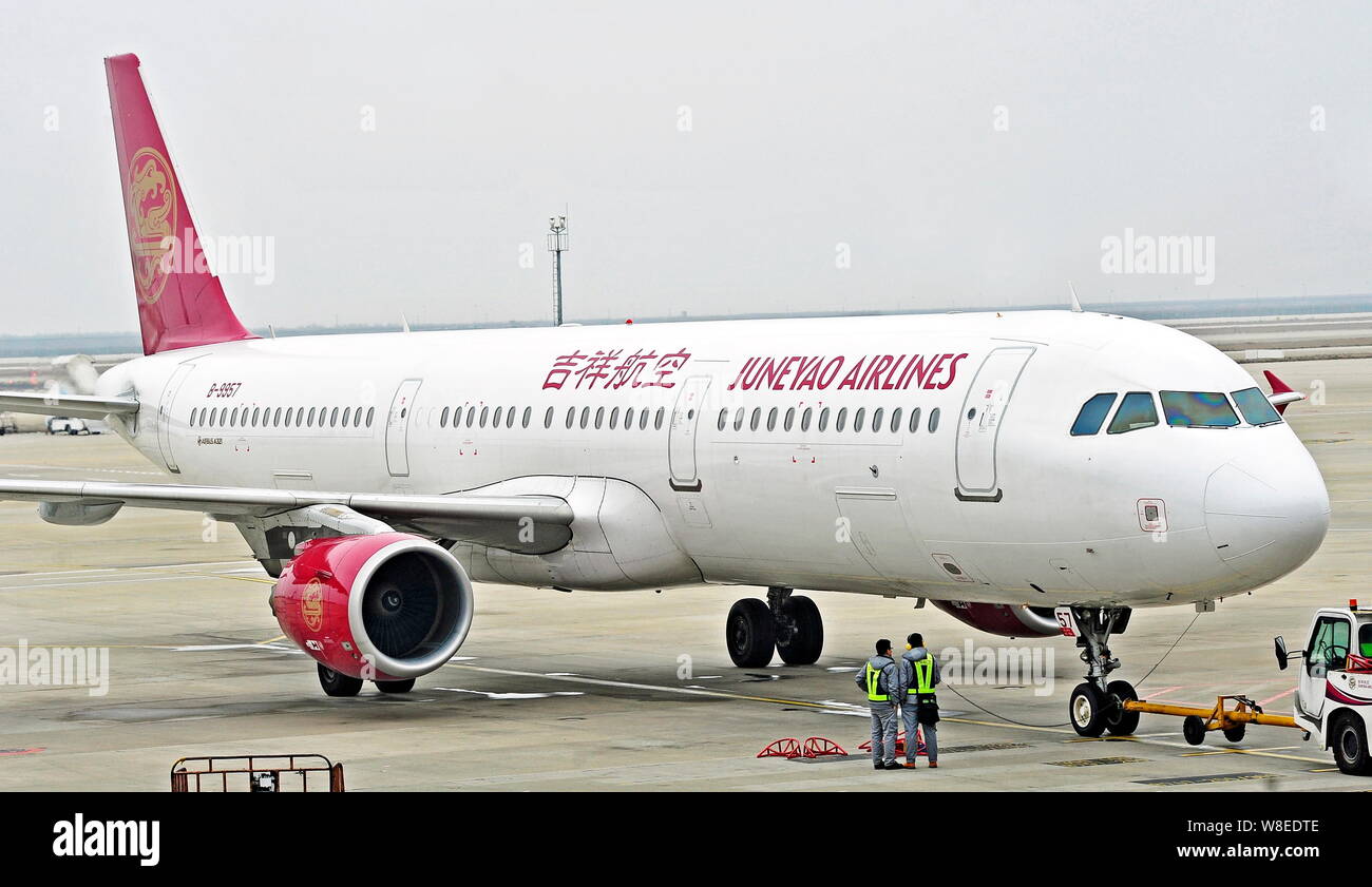--FILE--An Airbus A321 passenger jet of Juneyao Airlines is being towed to the parking apron at ...