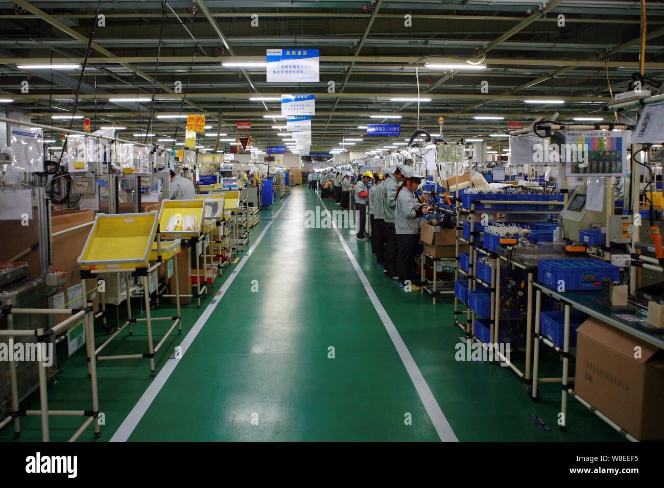 Chinese workers assemble smart toilet seats on the assembly line at a ... Chinese workers assemble smart toilet seats on the assembly line at a ...