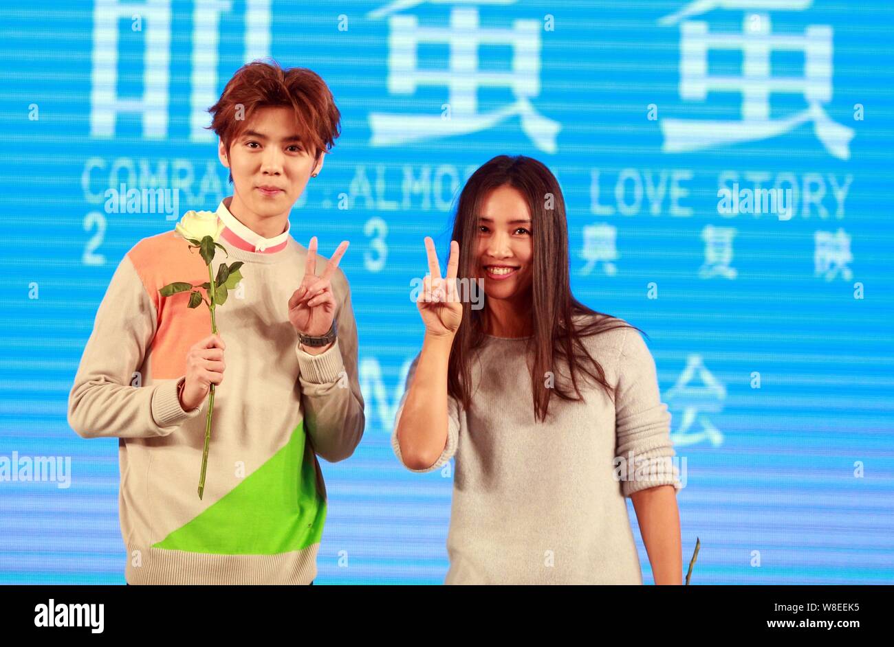 Chinese singer Lu Han, left, poses during a press conference for music ...