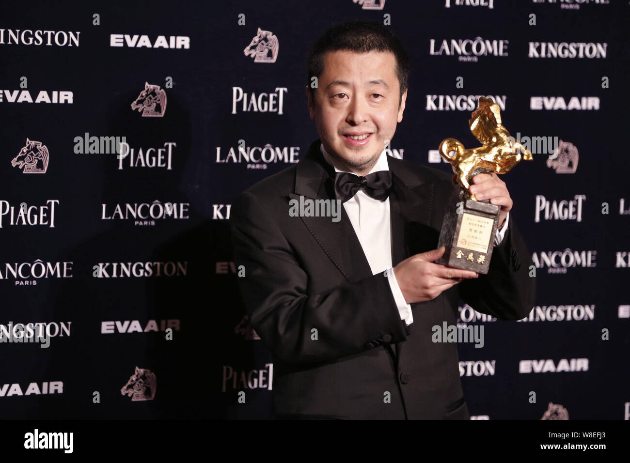 Chinese director Jia Zhangke poses with his trophy for Best Original ...