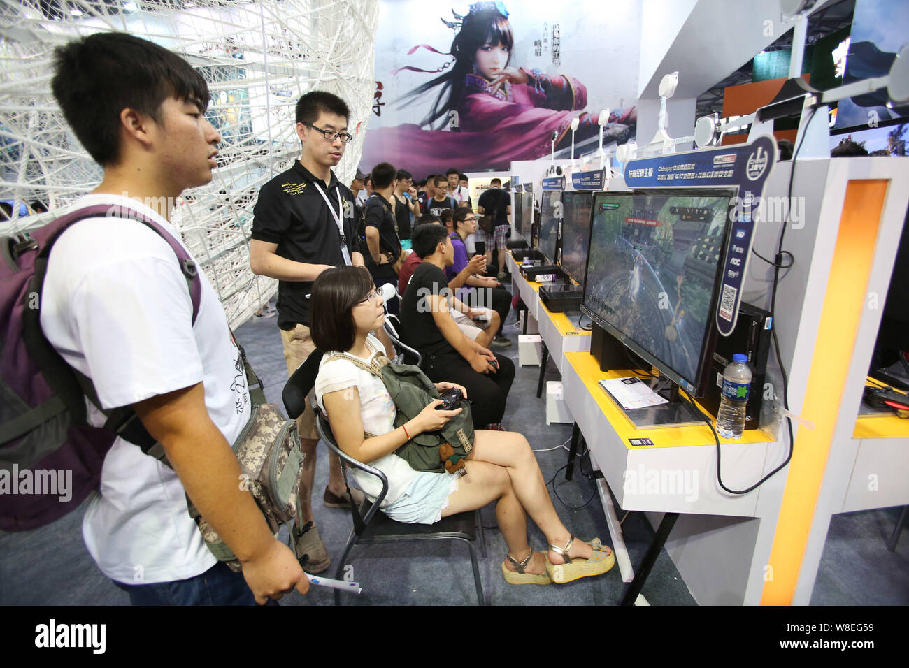 Visitors play electronic games on Microsoft's Xbox One game consoles ...