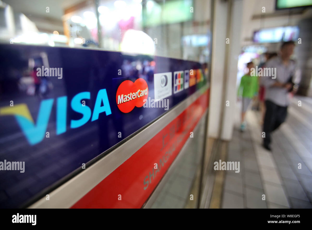 --FILE--A signboard of Visa and MasterCard is pictured at a store in ...