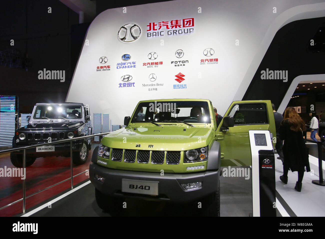 --FILE--Visitors look at cars at a stand of BAIC Motor during an auto ...