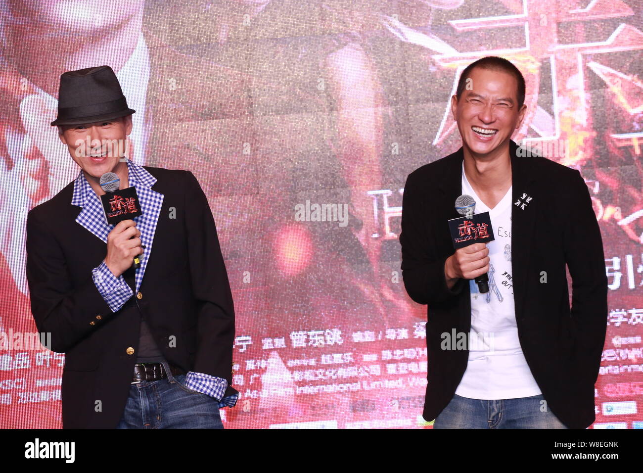 Hong Kong singers and actors Jacky Cheung, left, and Nick Cheung react ...