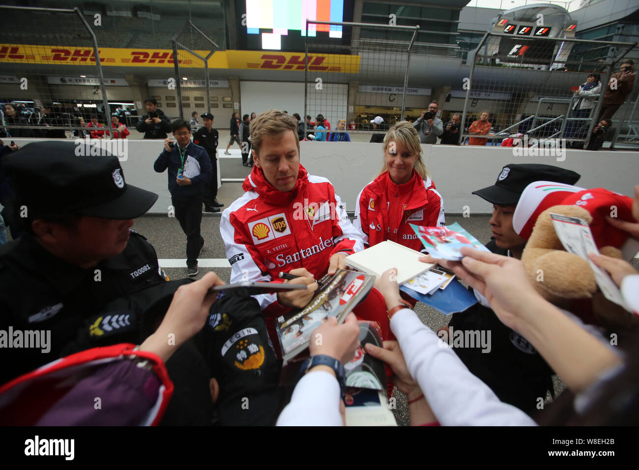 German F1 driver Sebastian Vettel of Ferrari signs autographs for fans ...
