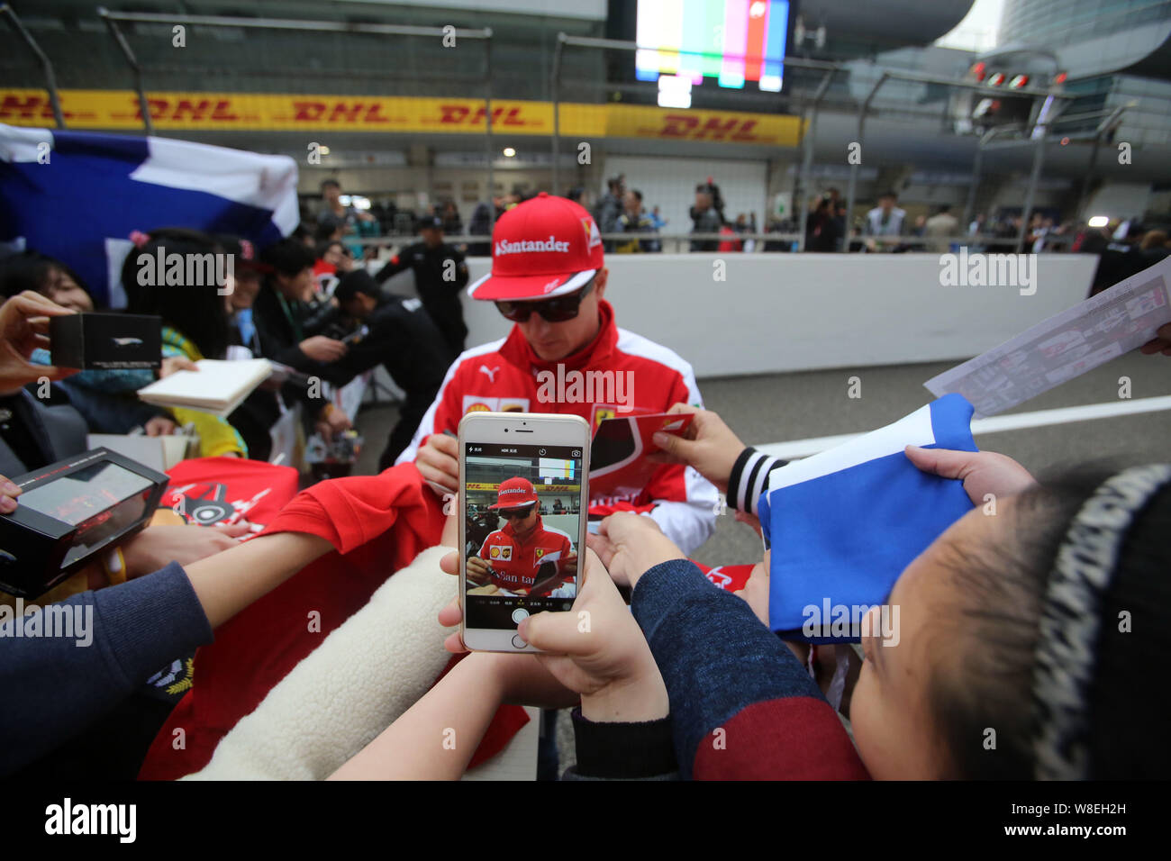 Finnish F1 driver Kimi Raikkonen of Ferrari signs autographs for fans ...