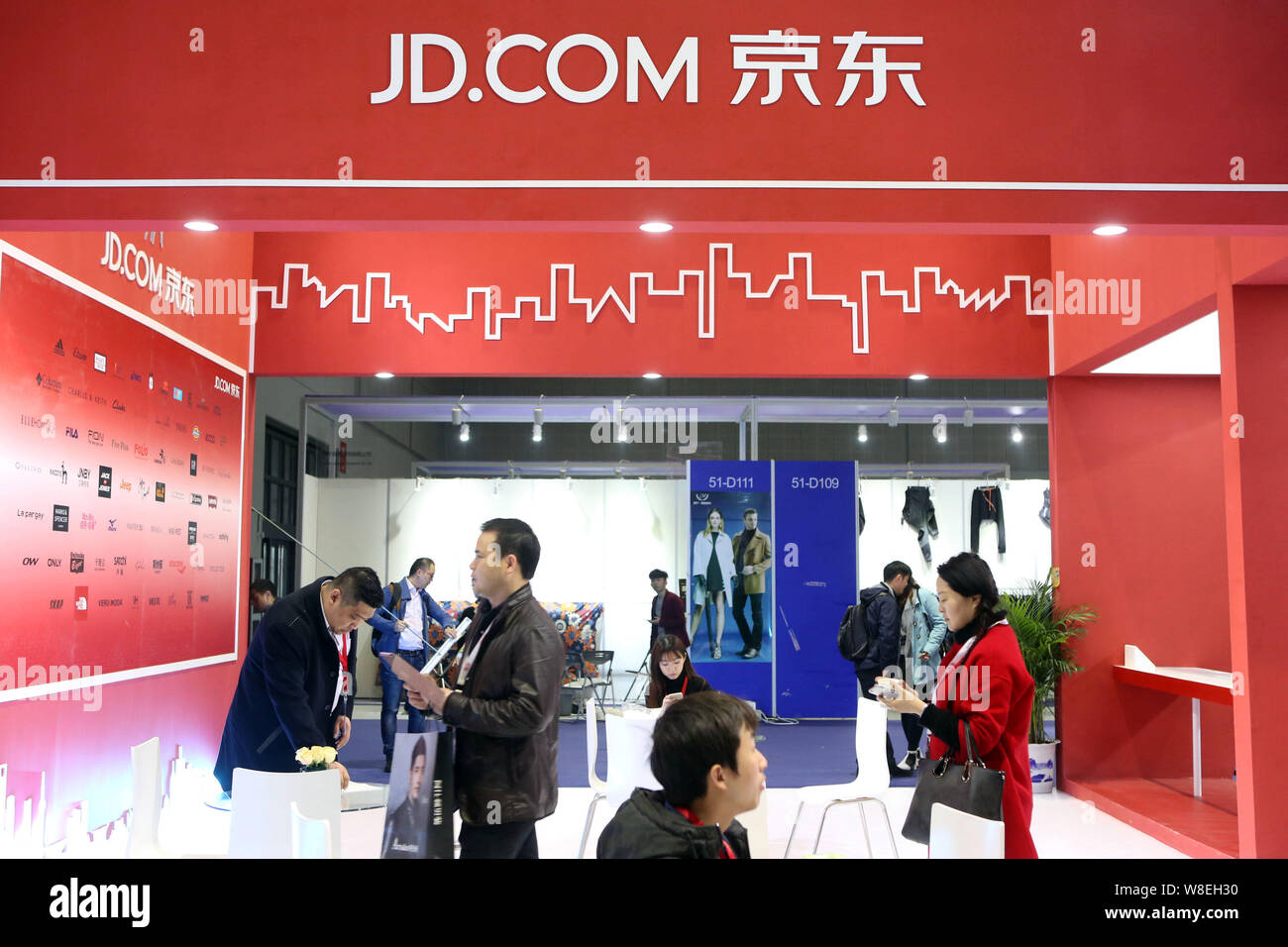 People visit the stand of Chinese online shopping site JD.com, also ...