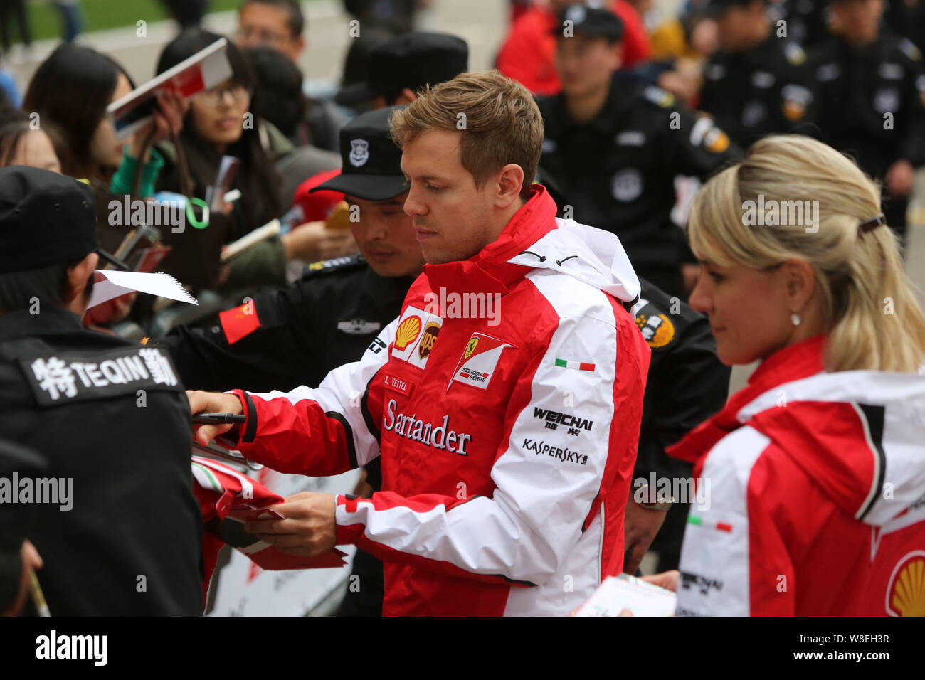 German F1 driver Sebastian Vettel of Ferrari signs autographs for fans ...