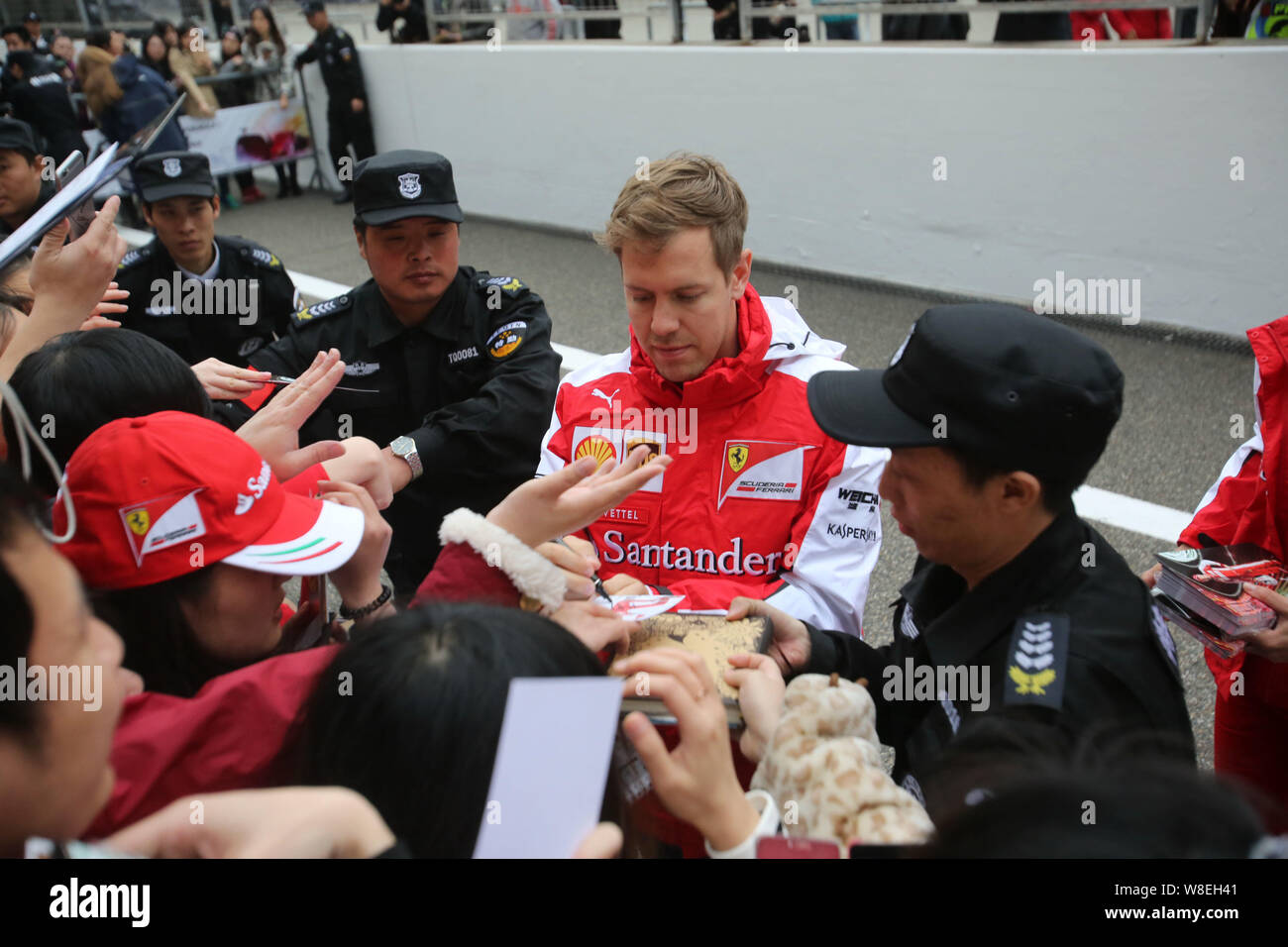 German F1 driver Sebastian Vettel of Ferrari signs autographs for fans ...