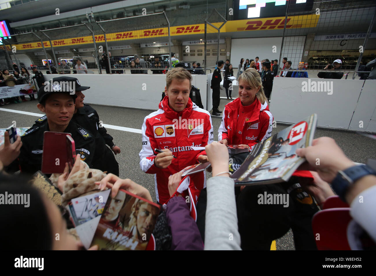 German F1 driver Sebastian Vettel of Ferrari signs autographs for fans ...