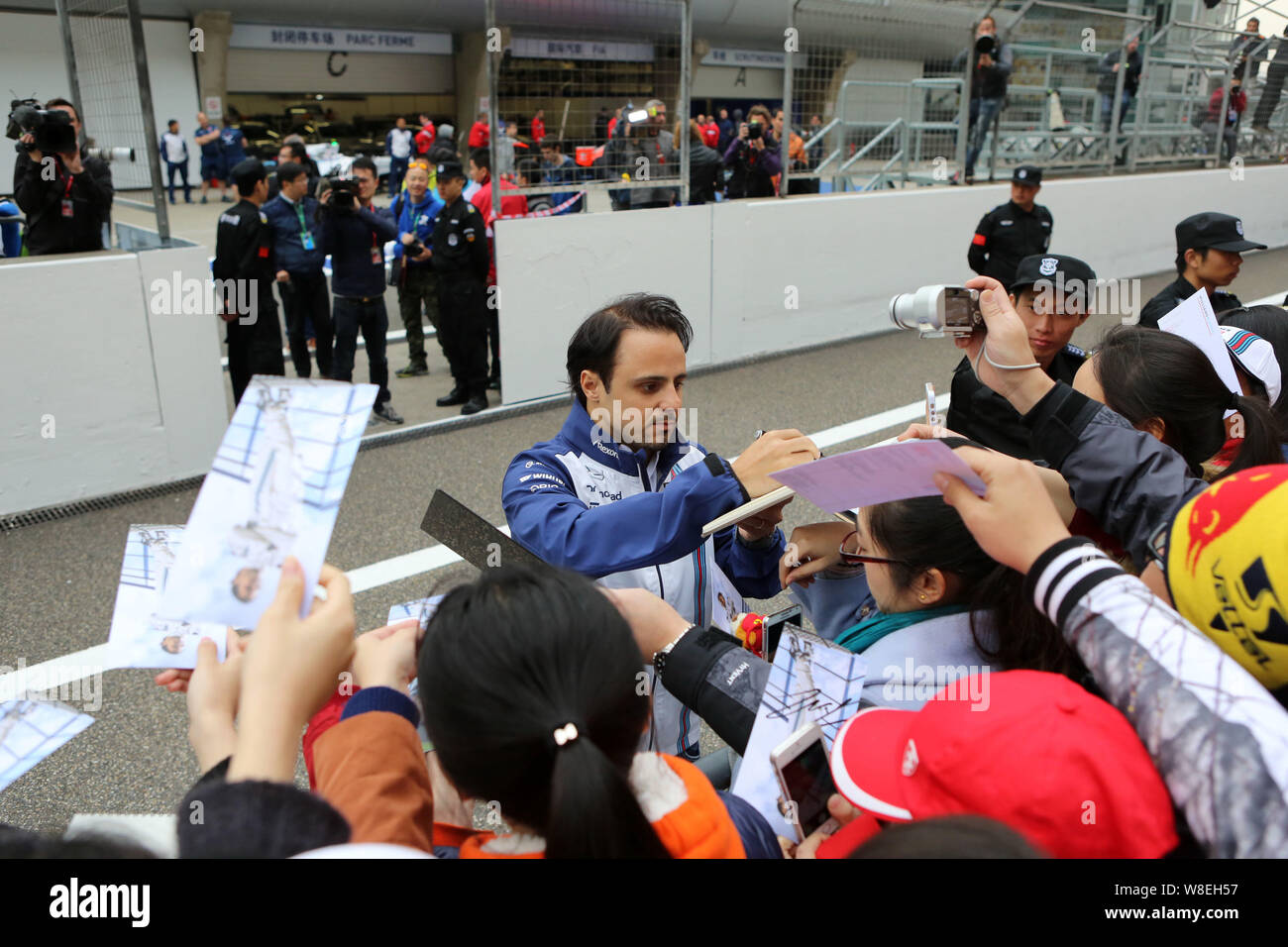 Brazilian F1 driver Felipe Massa of Williams signs autographs for fans ...