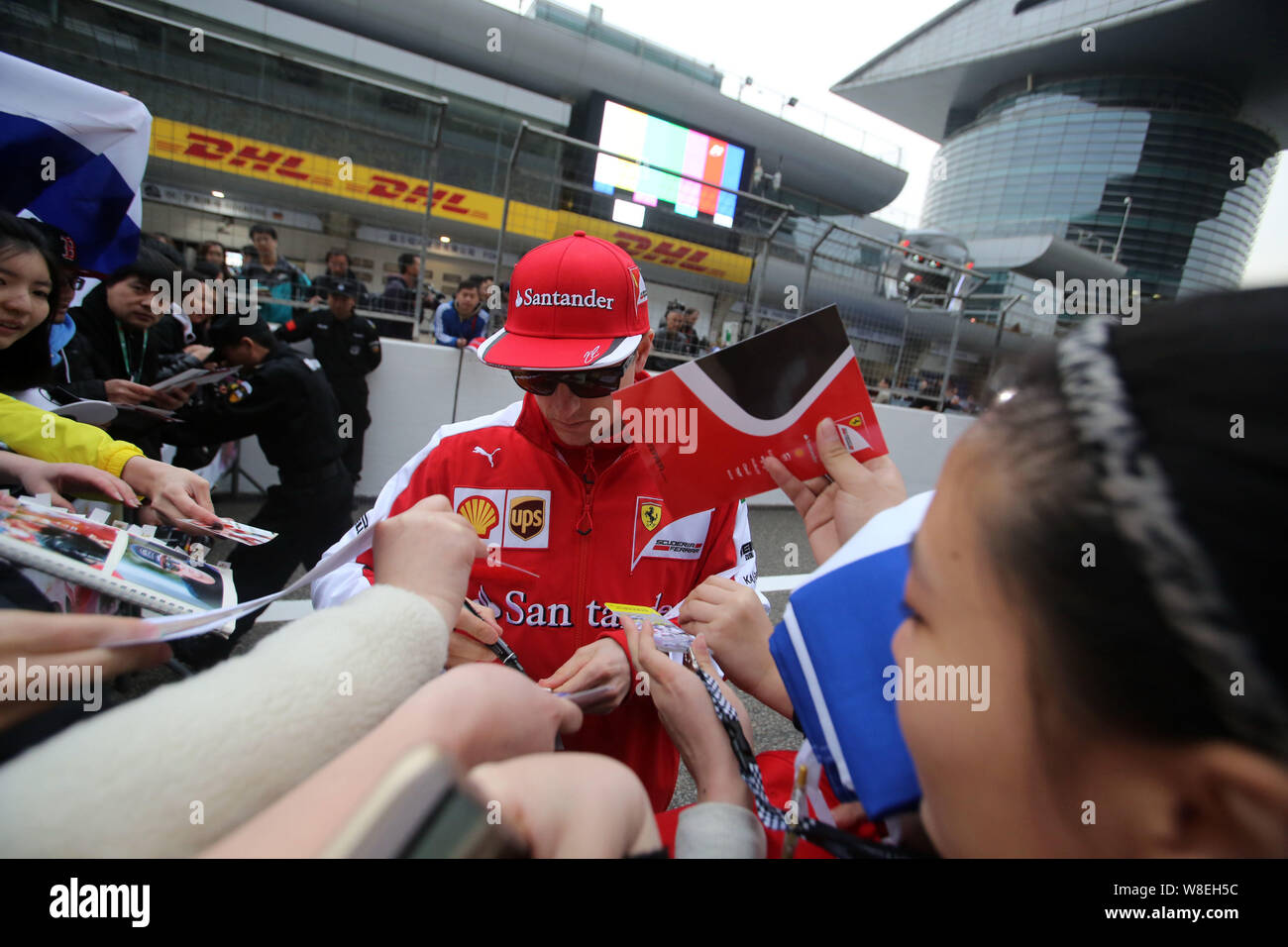 Finnish F1 driver Kimi Raikkonen of Ferrari signs autographs for fans ...