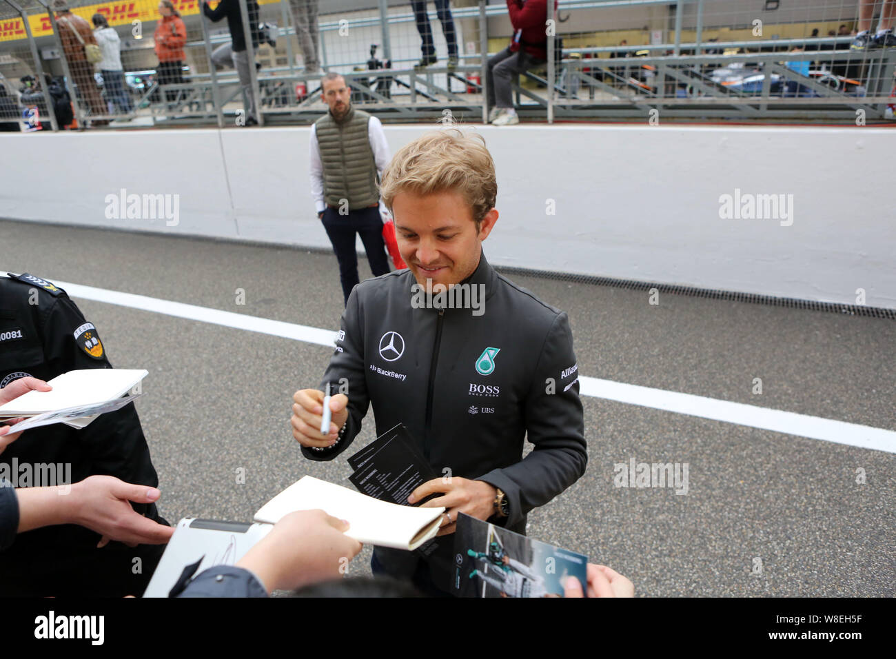 German F1 driver Nico Rosberg of Mercedes signs autographs for fans at ...