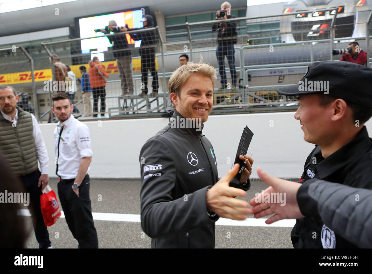 German F1 driver Nico Rosberg of Mercedes shakes hands with a fan at ...