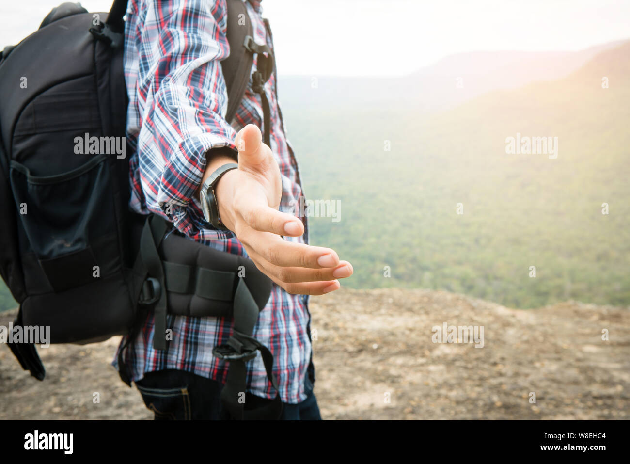 tourist hold helping hand Stock Photo - Alamy