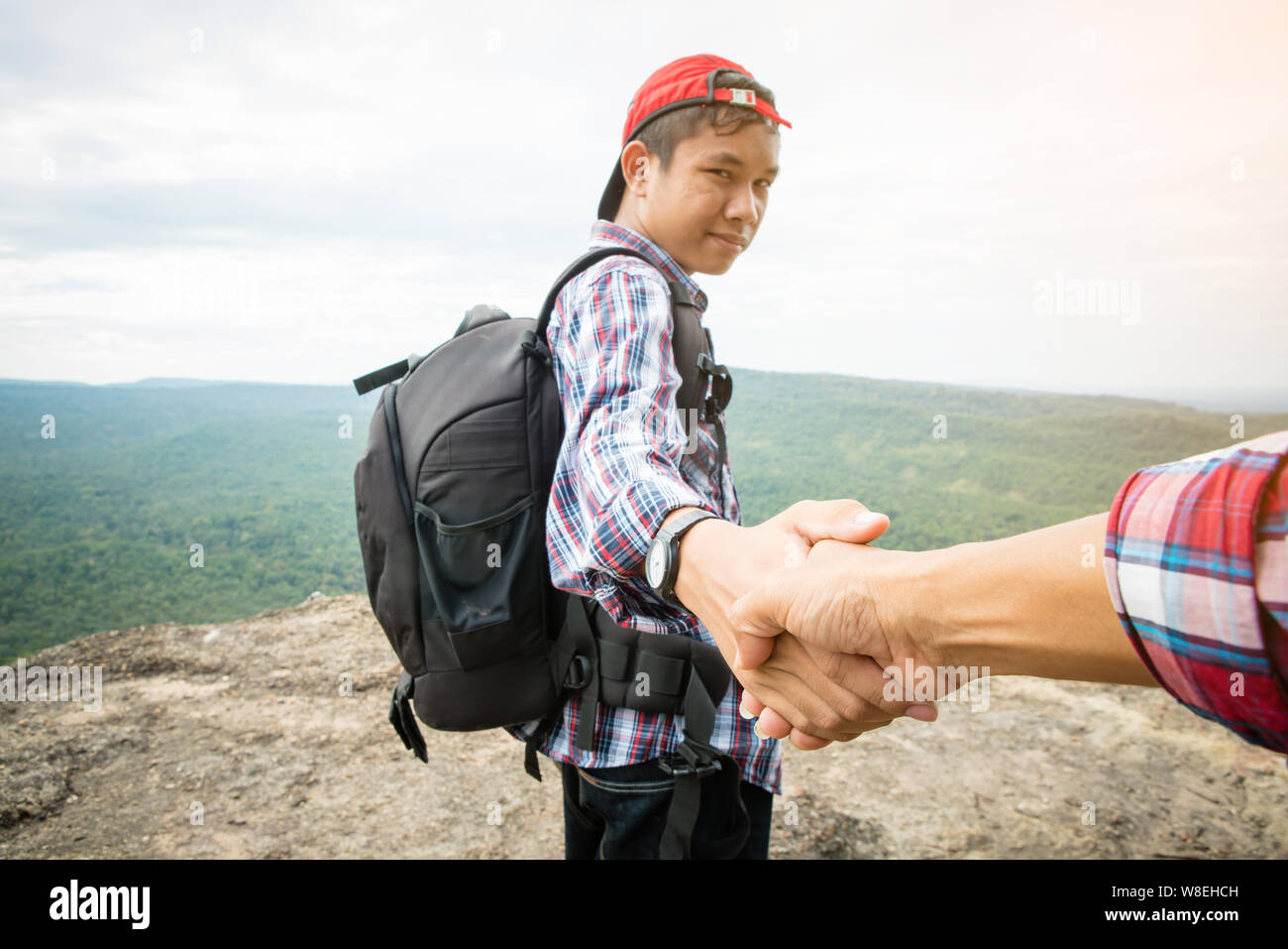 tourist hold helping hand Stock Photo - Alamy