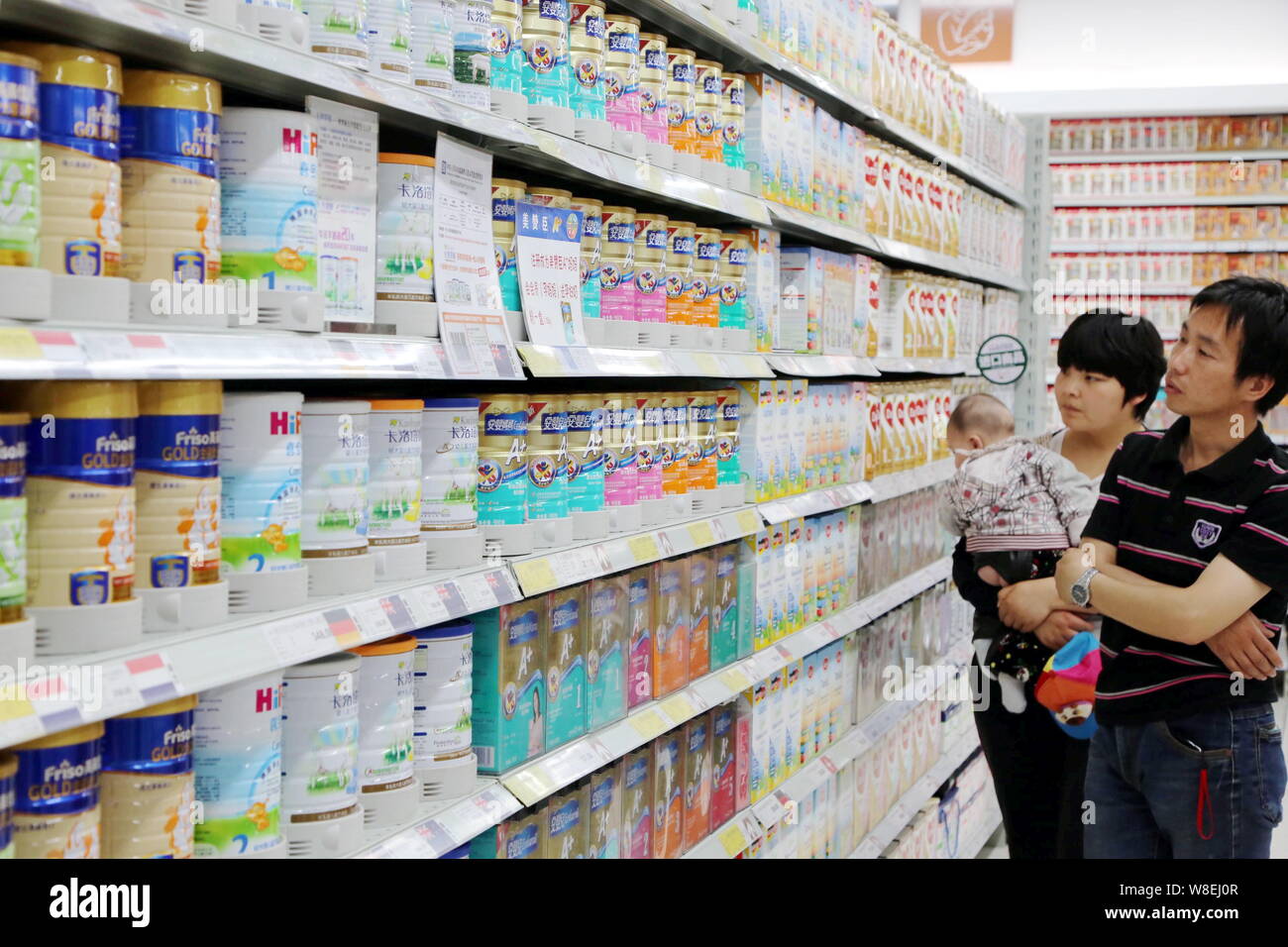 --FILE--A Chinese family of three shops for baby formula at a ...