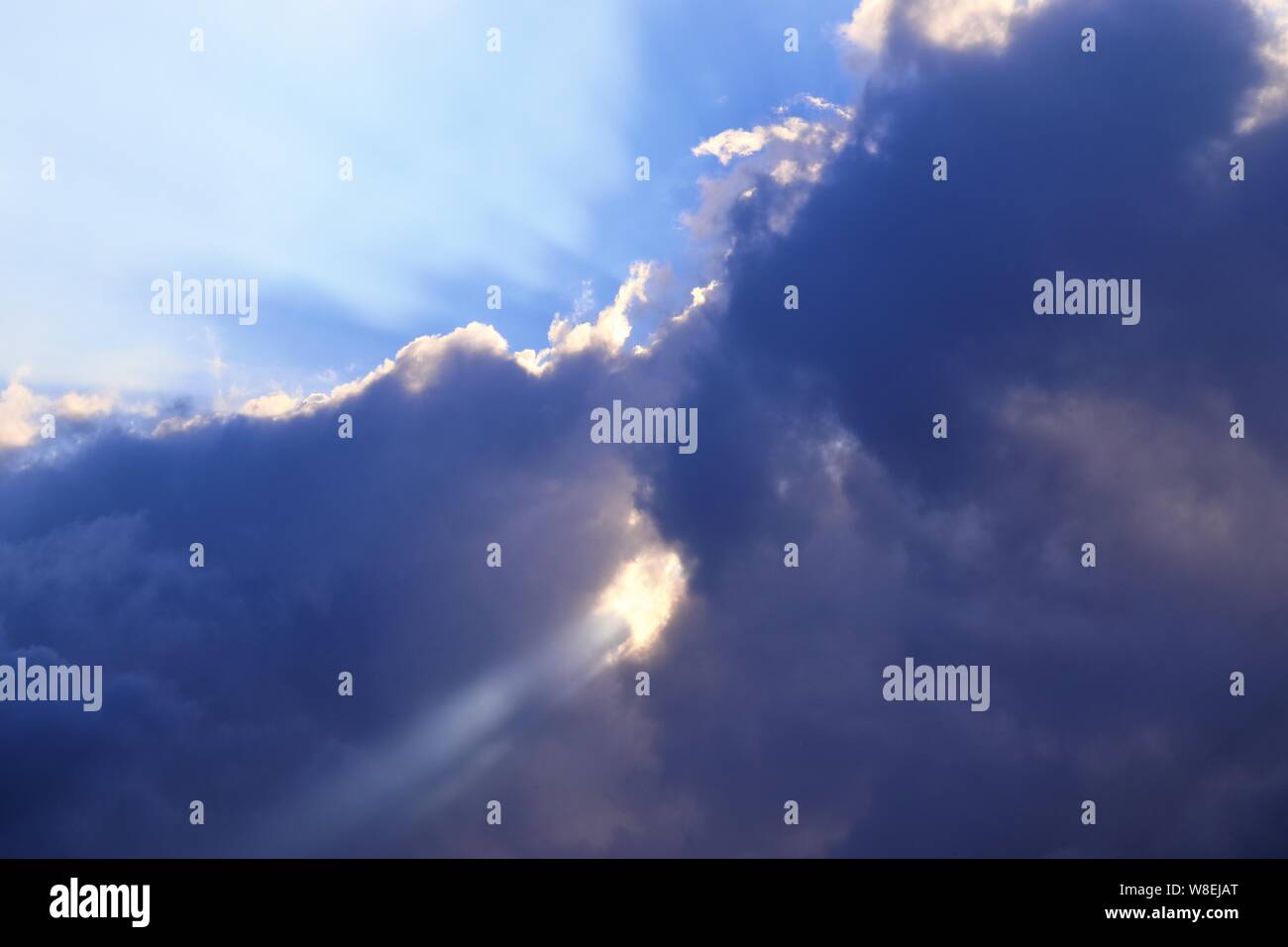 Beautiful sunlight beams through clouds on a sunset summer sky Stock ...
